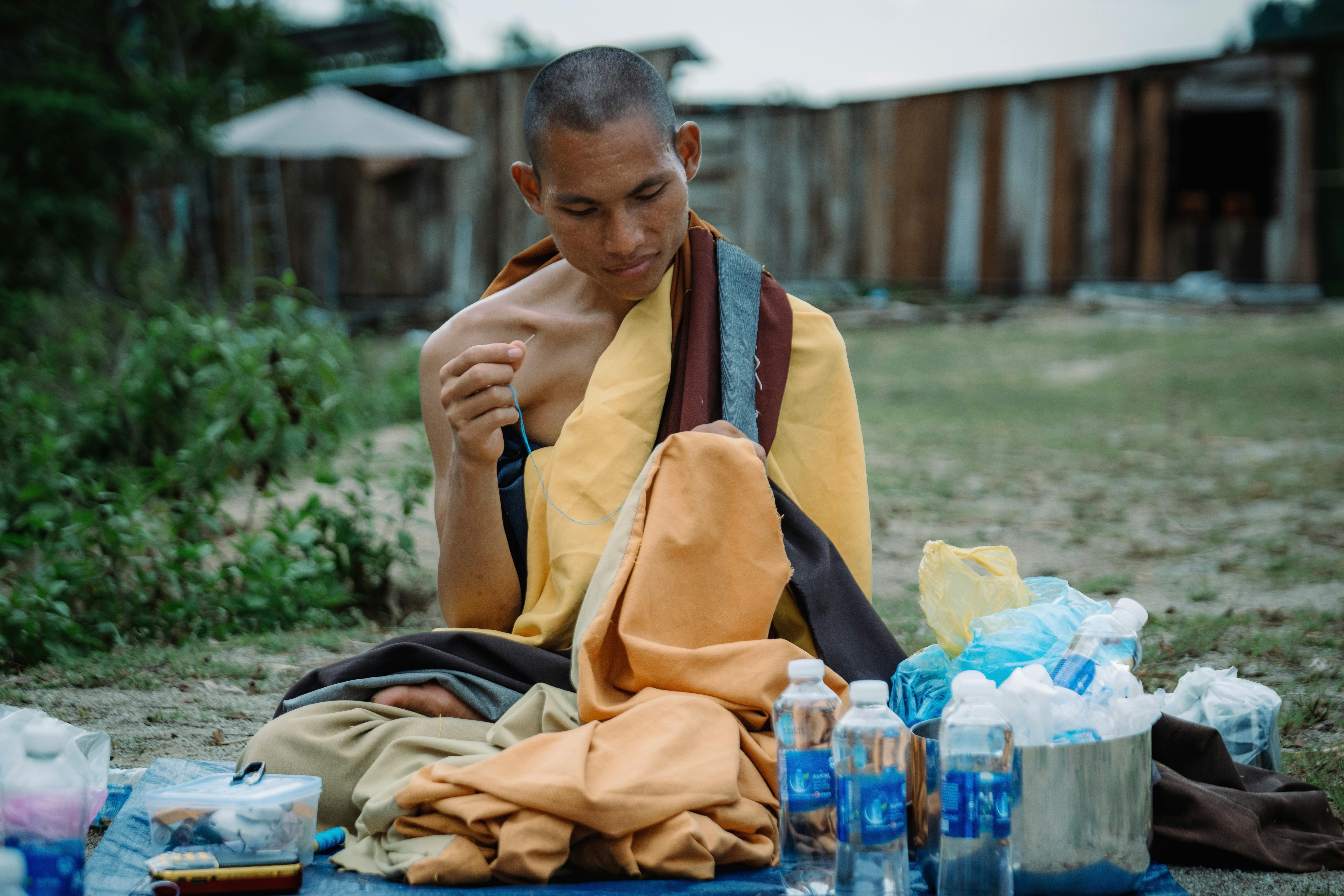Buddhist Monk Sitting on a Mat · Free Stock Photo