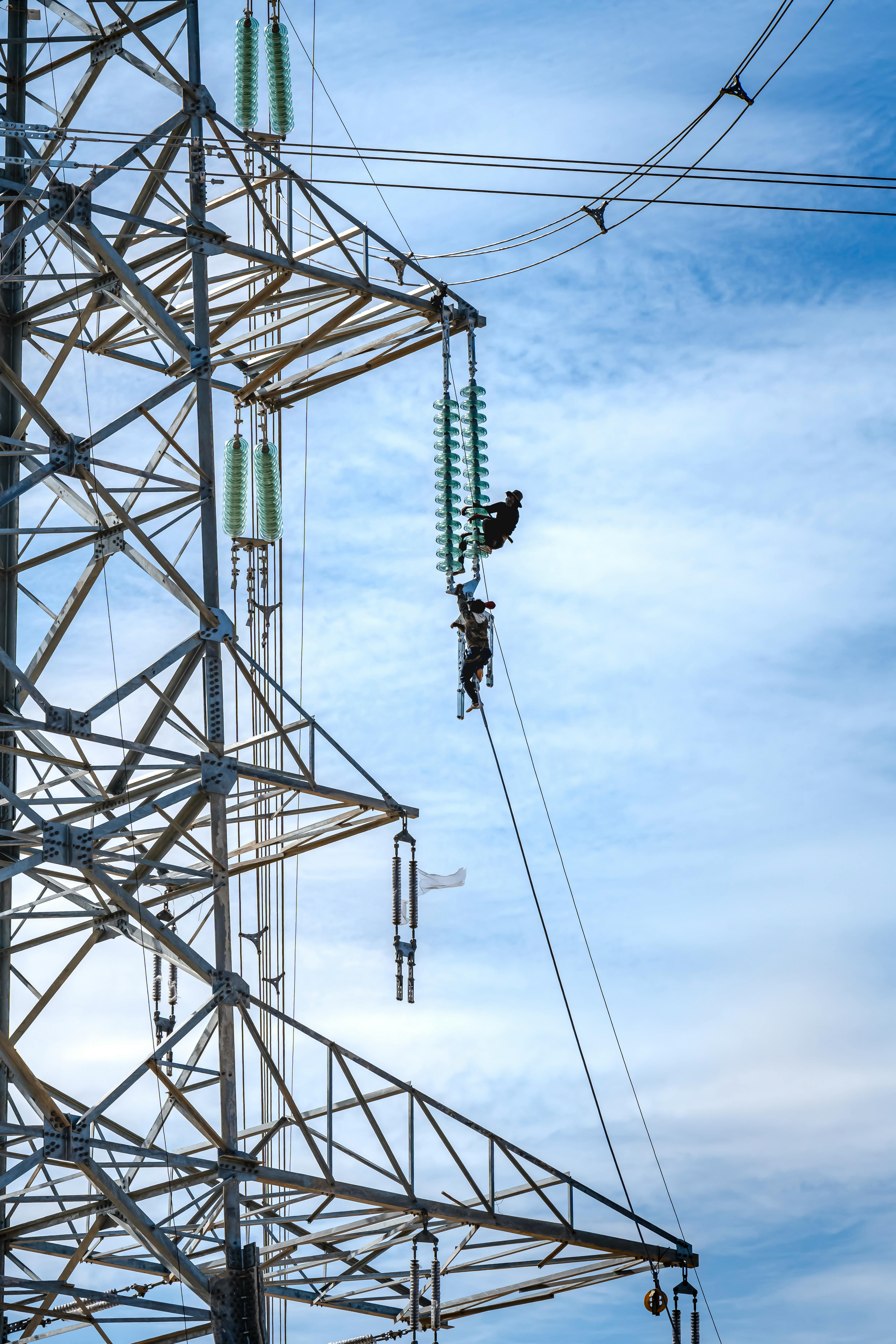 Men Working on Transmission Tower · Free Stock Photo