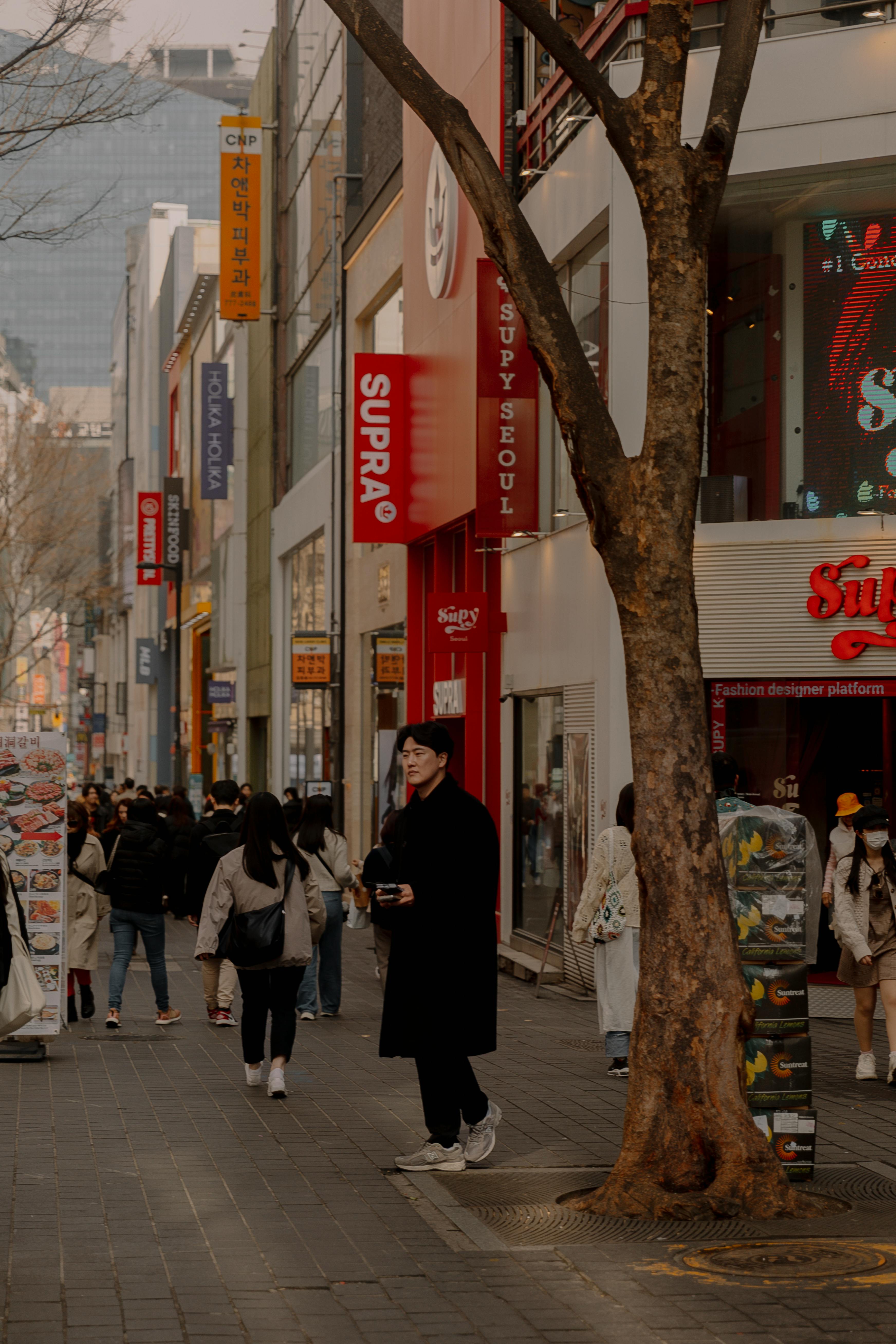 People on Street Among Shops · Free Stock Photo
