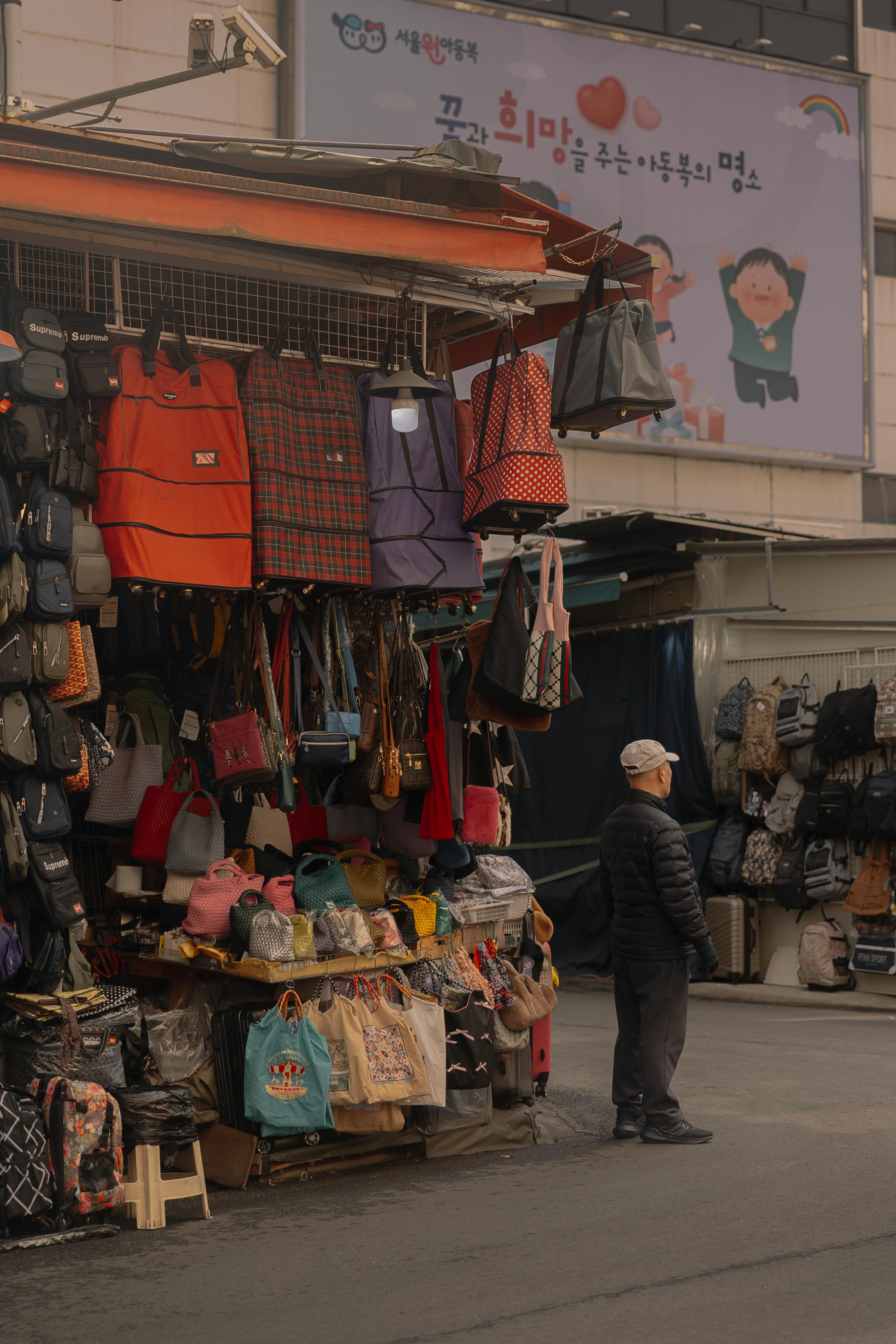Man Selling Clothes in Bazaar · Free Stock Photo