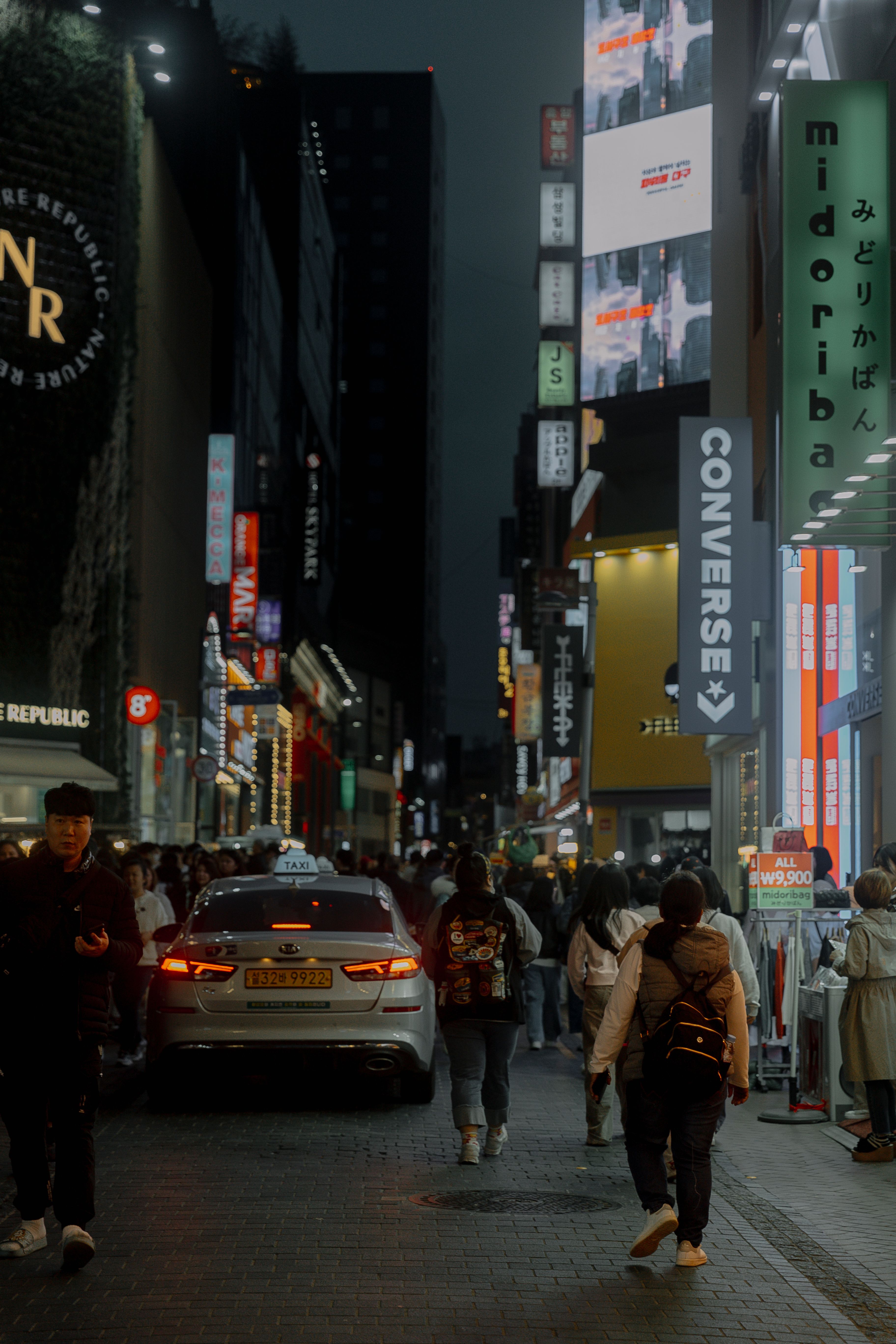 People walking down a busy street at night · Free Stock Photo
