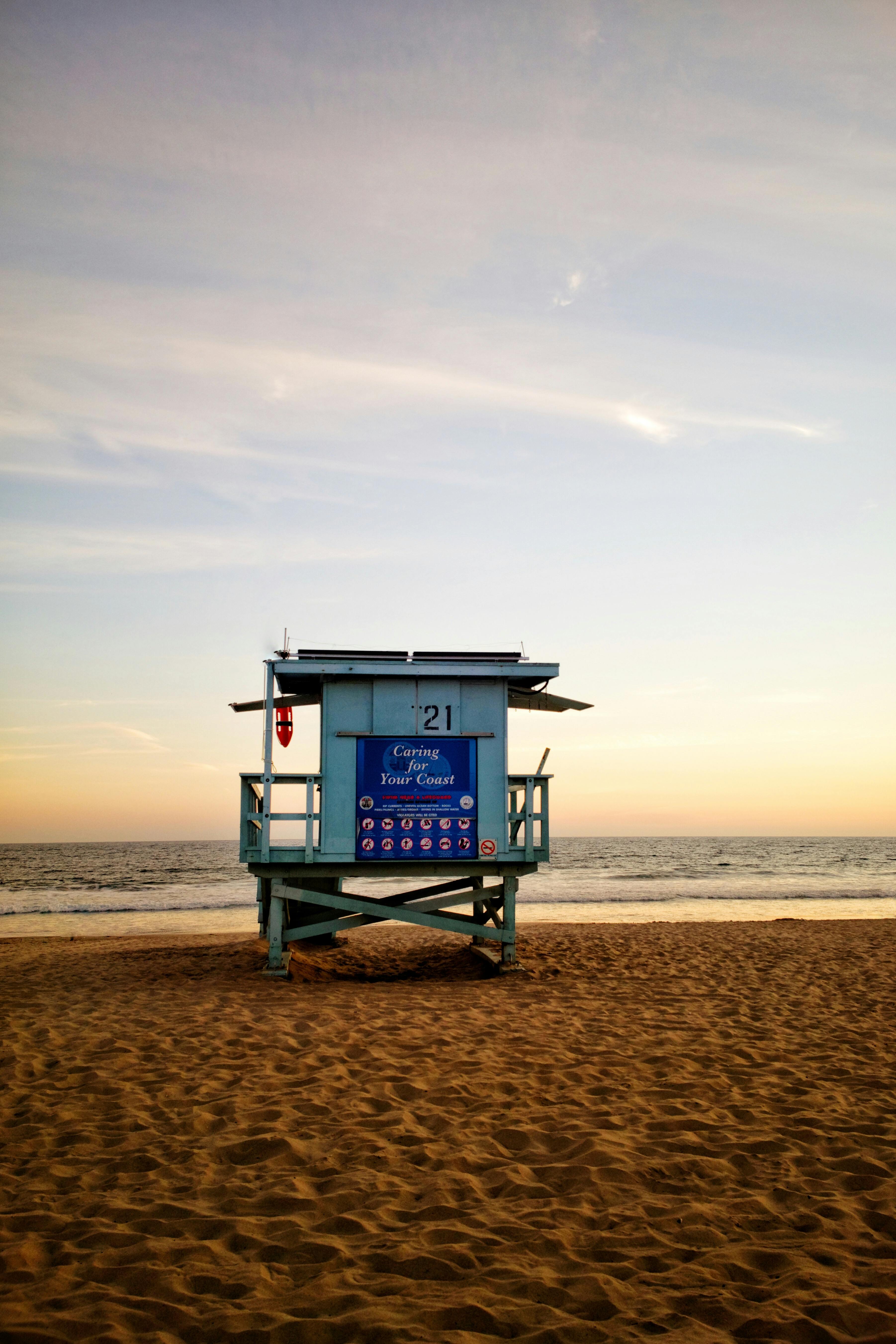Silhouette of Life Guard House Near Ocean during Sunset · Free Stock Photo