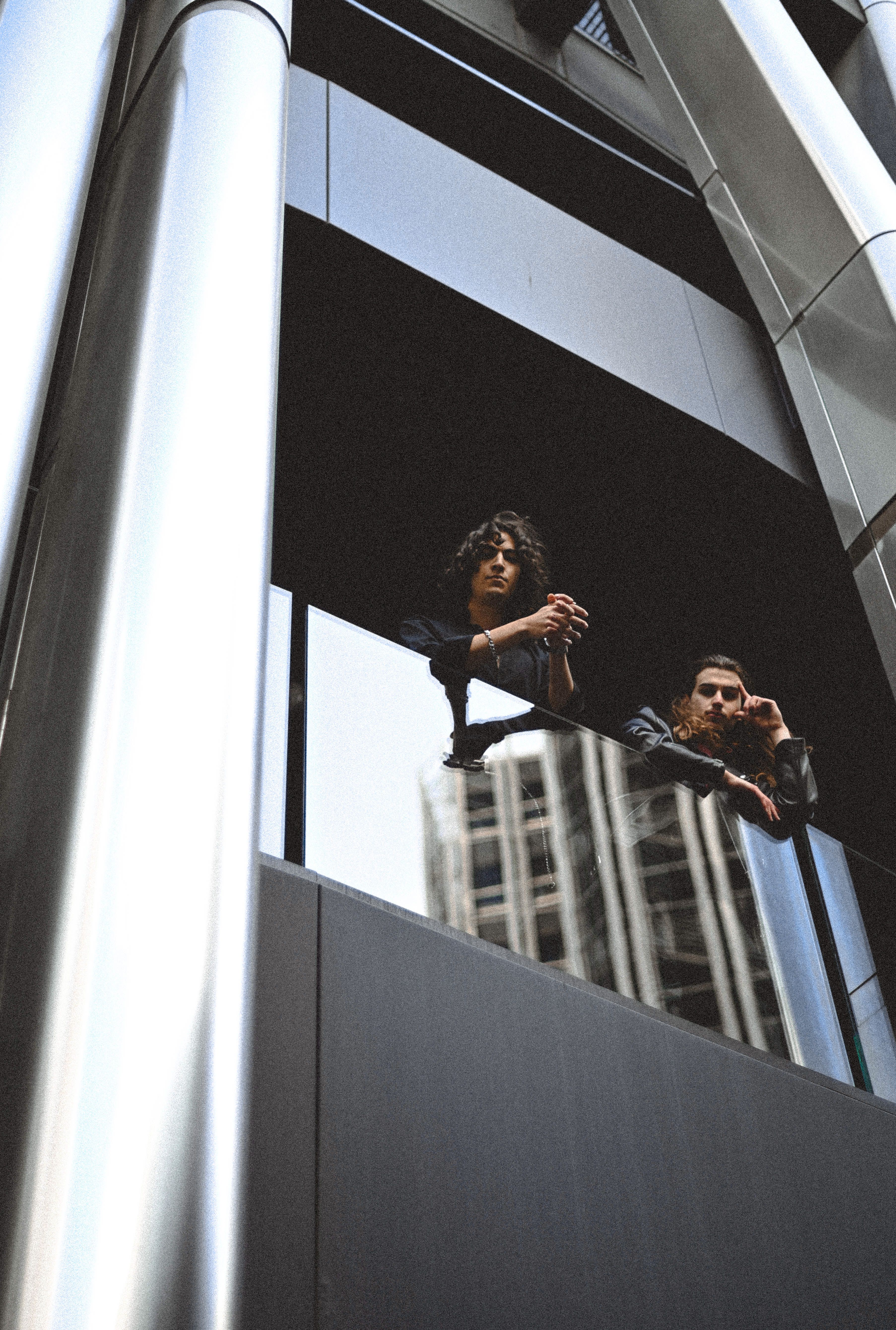 Men Leaning over Window of Office Building · Free Stock Photo