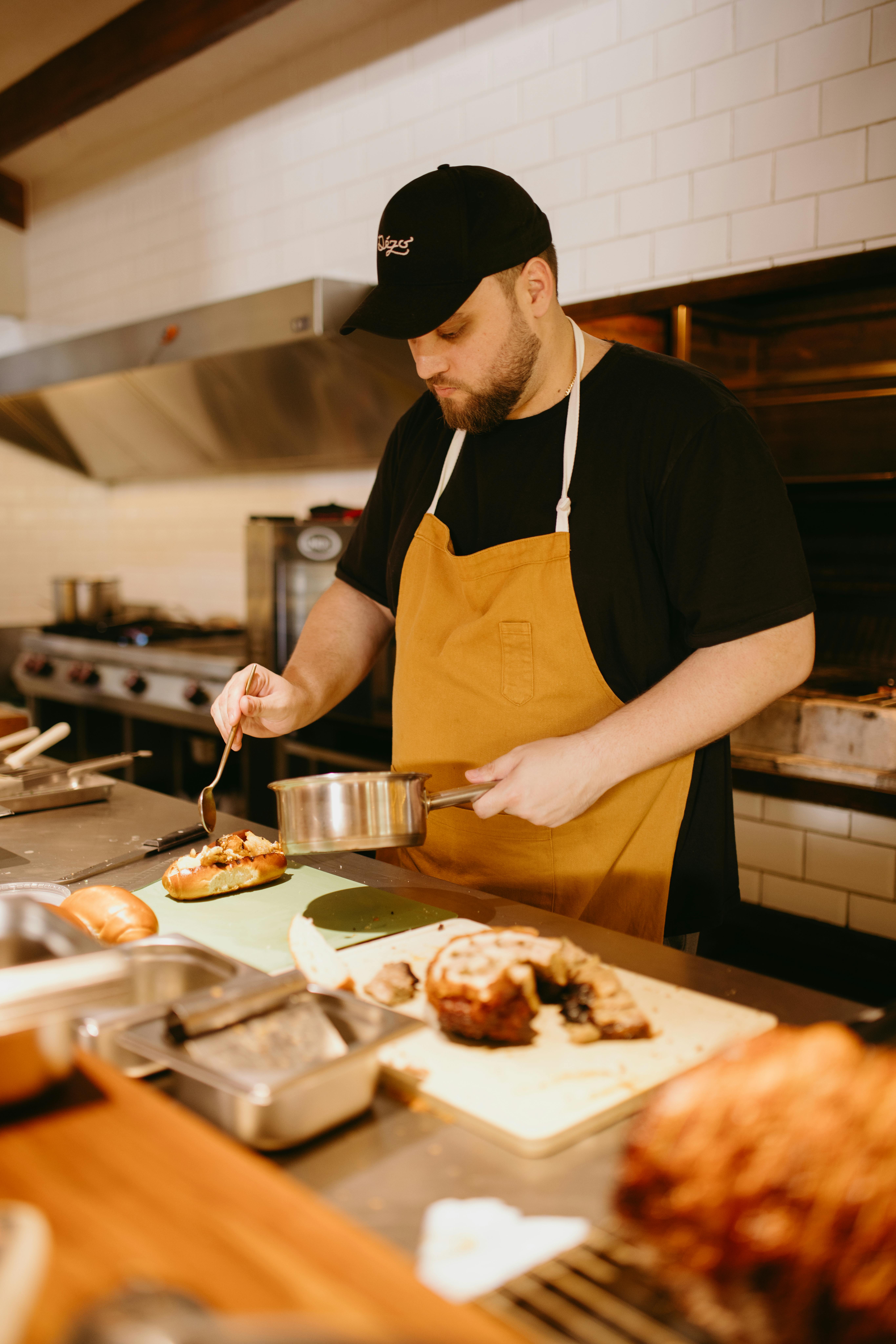 Man and Woman Wearing Black and White Striped Aprons Cooking · Free ...