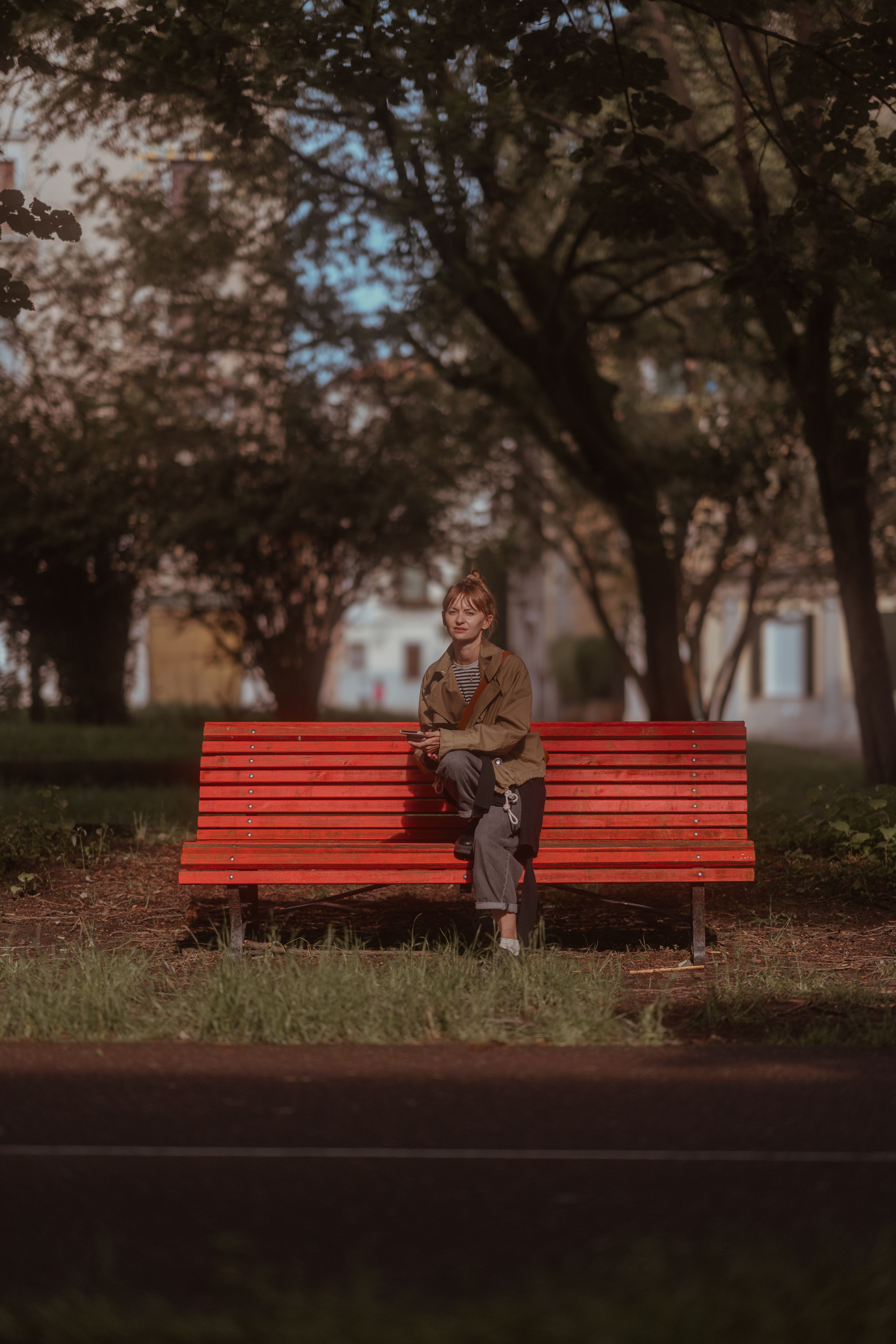 Beautiful Woman Sitting on Red Bench · Free Stock Photo