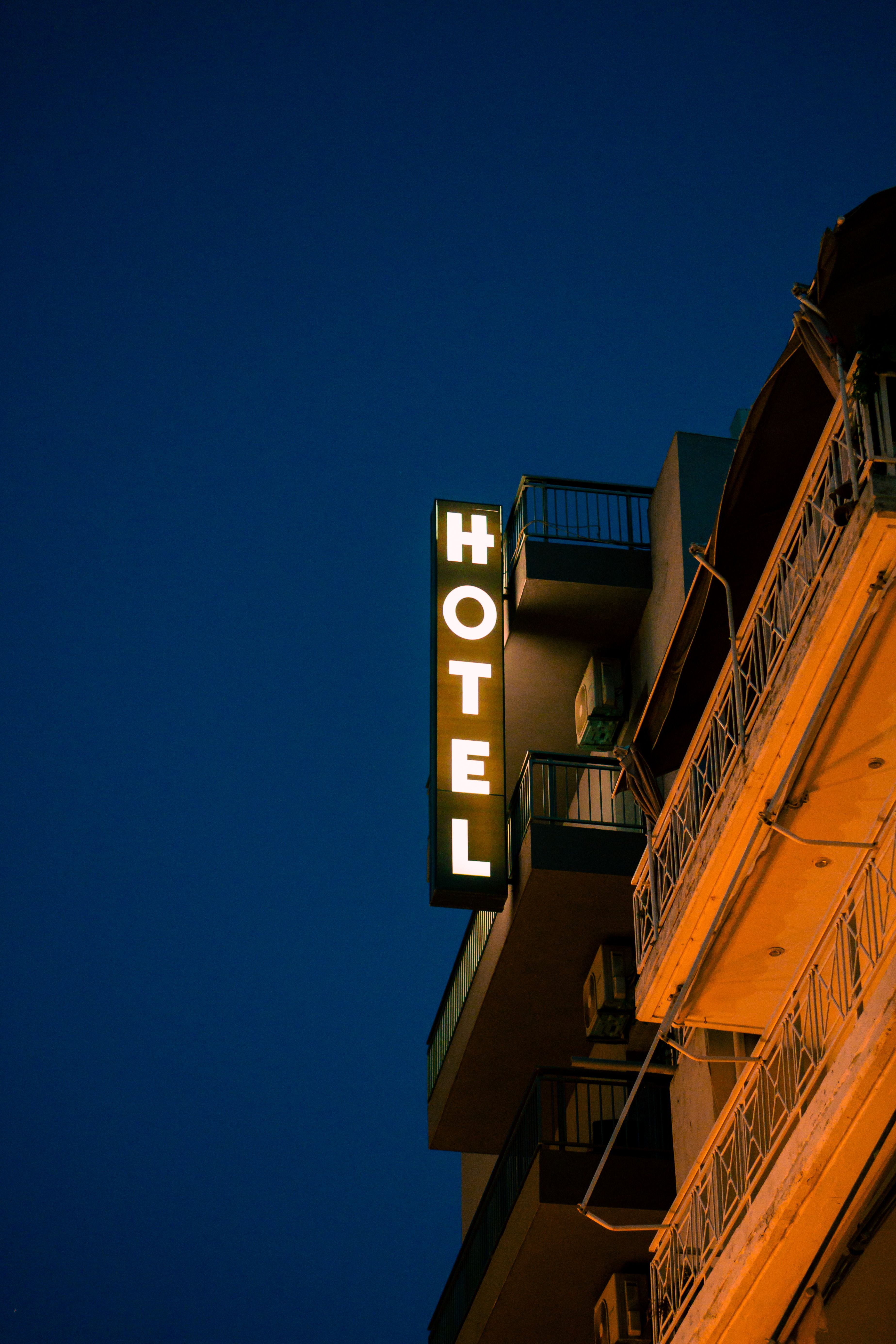 Illuminated Hotel Sign on the Side of a Building · Free Stock Photo