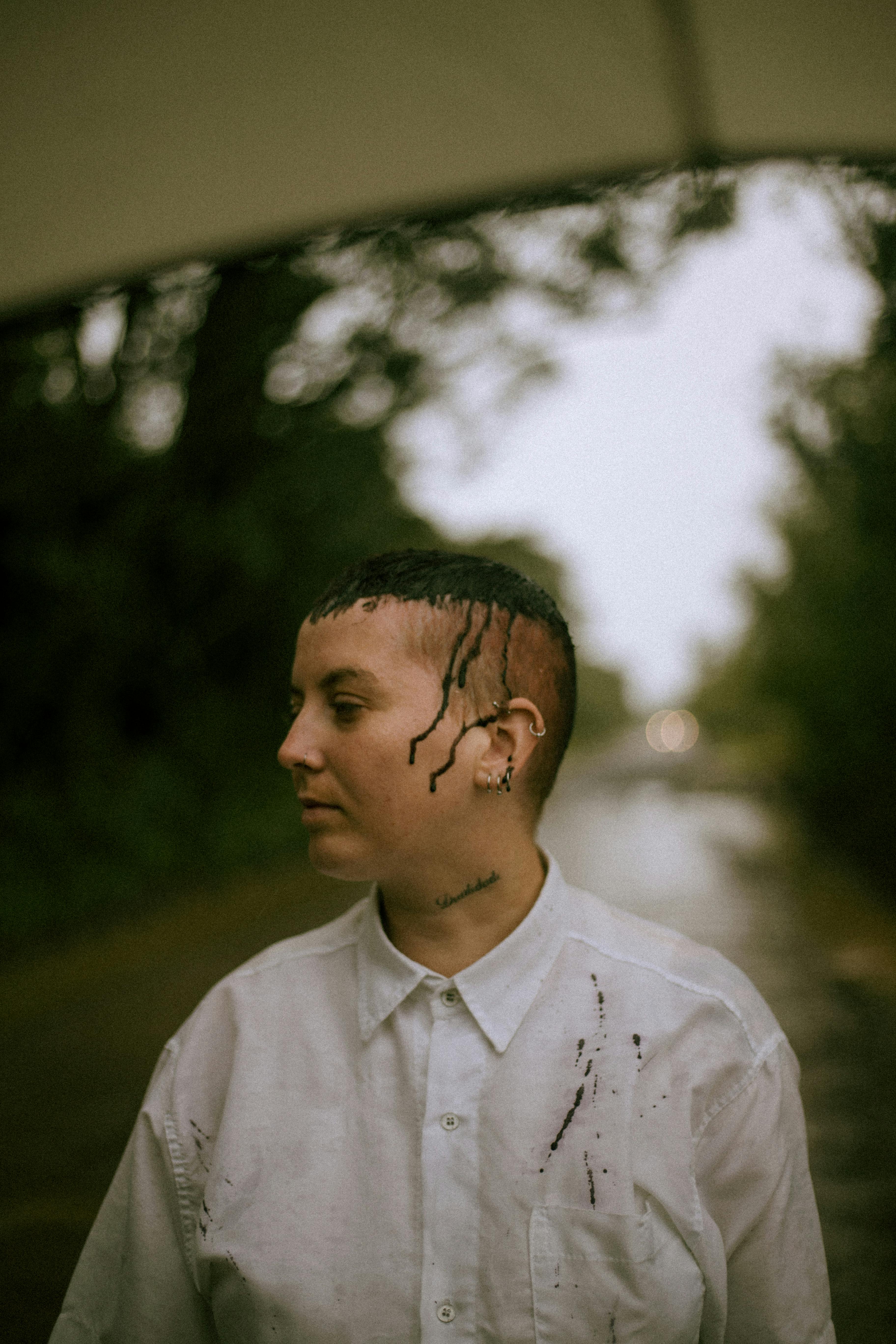 A Young Person with Ink Dripping Down Their Face onto Their Shirt ...