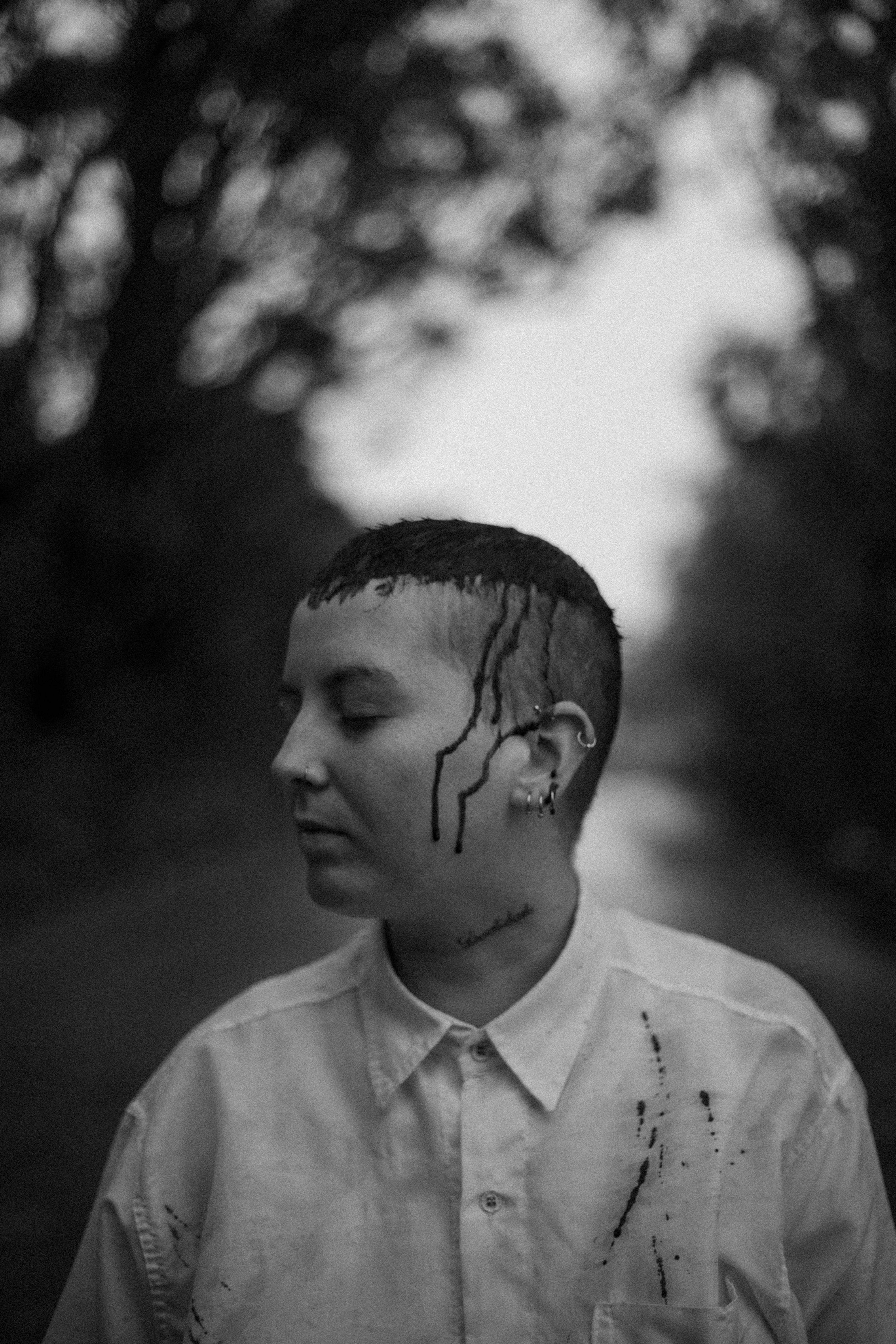 A Young Person with Ink Dripping Down Their Face onto Their Shirt ...