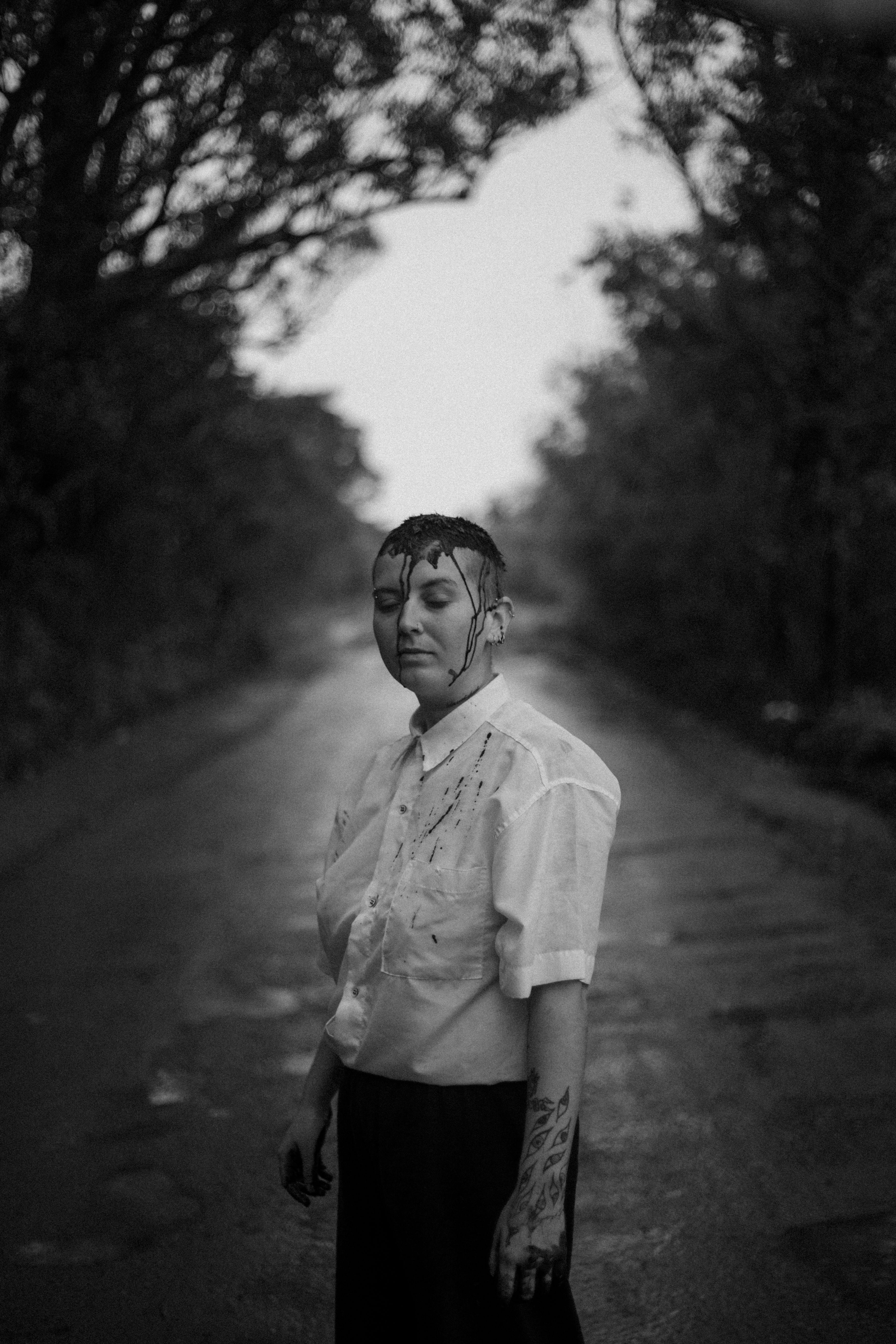 A Young Person with Ink Dripping Down Their Face onto Their Shirt ...