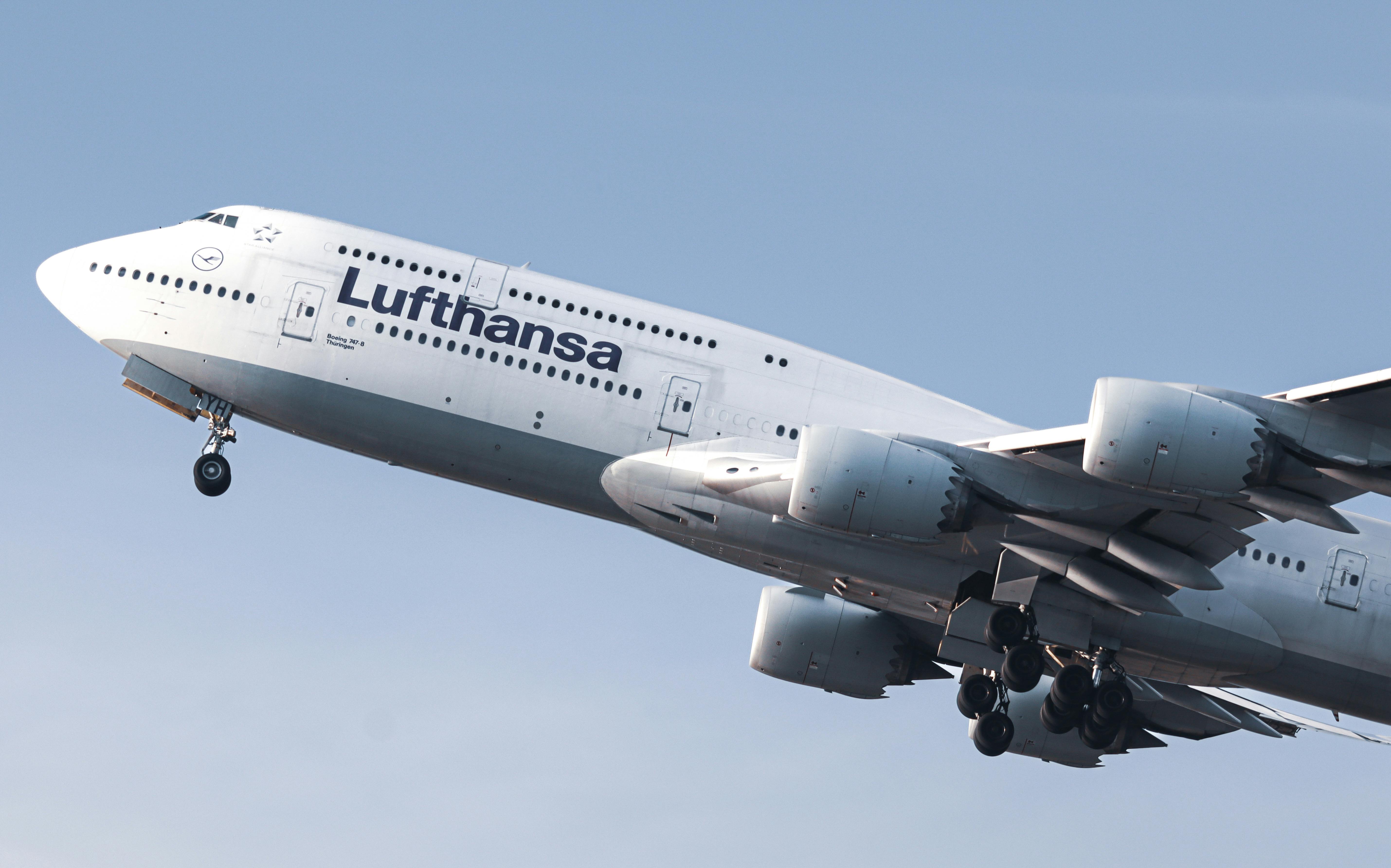 A large airplane flying through the sky · Free Stock Photo