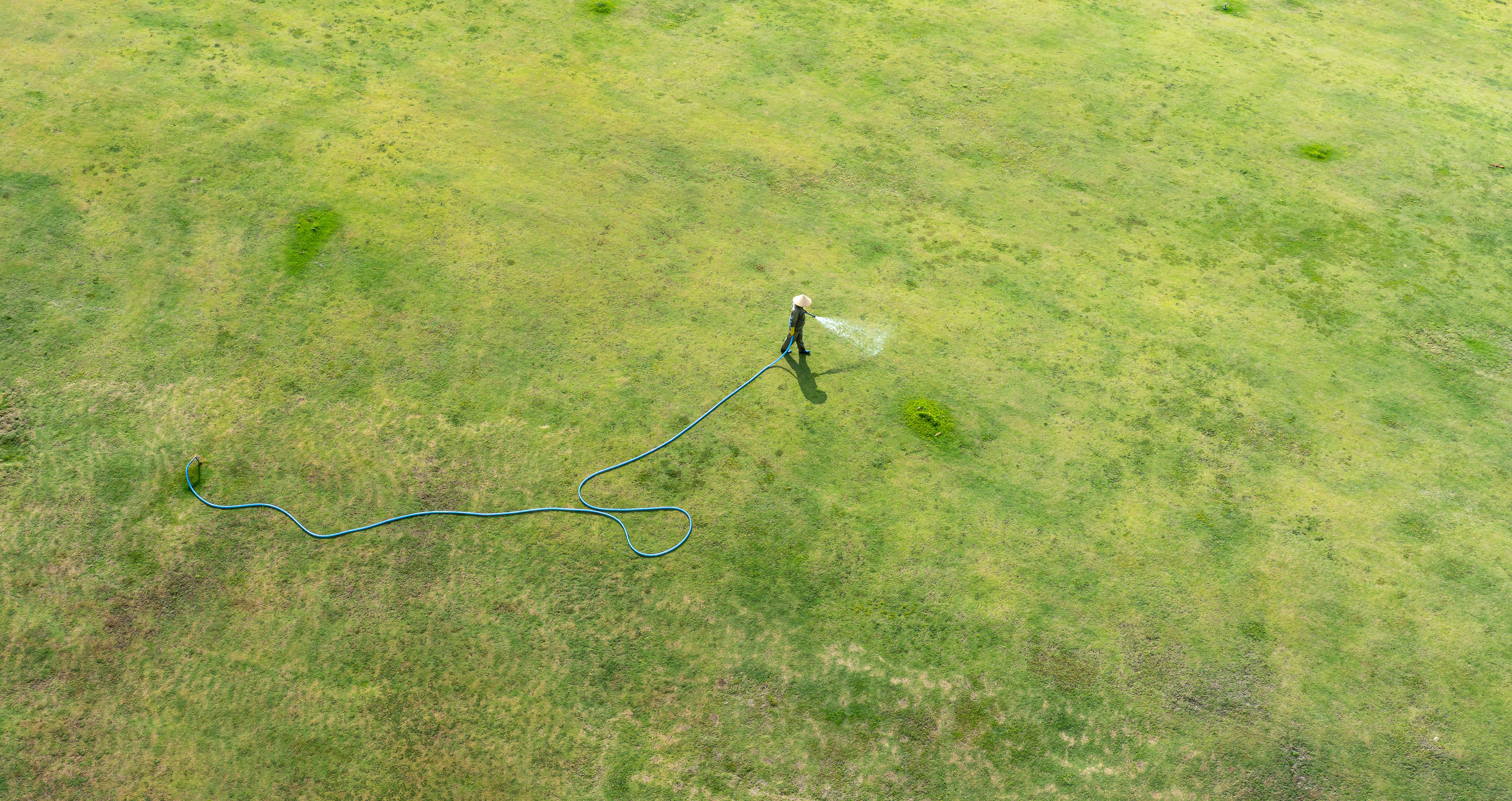 Aerial View of a Person Watering the Field · Free Stock Photo