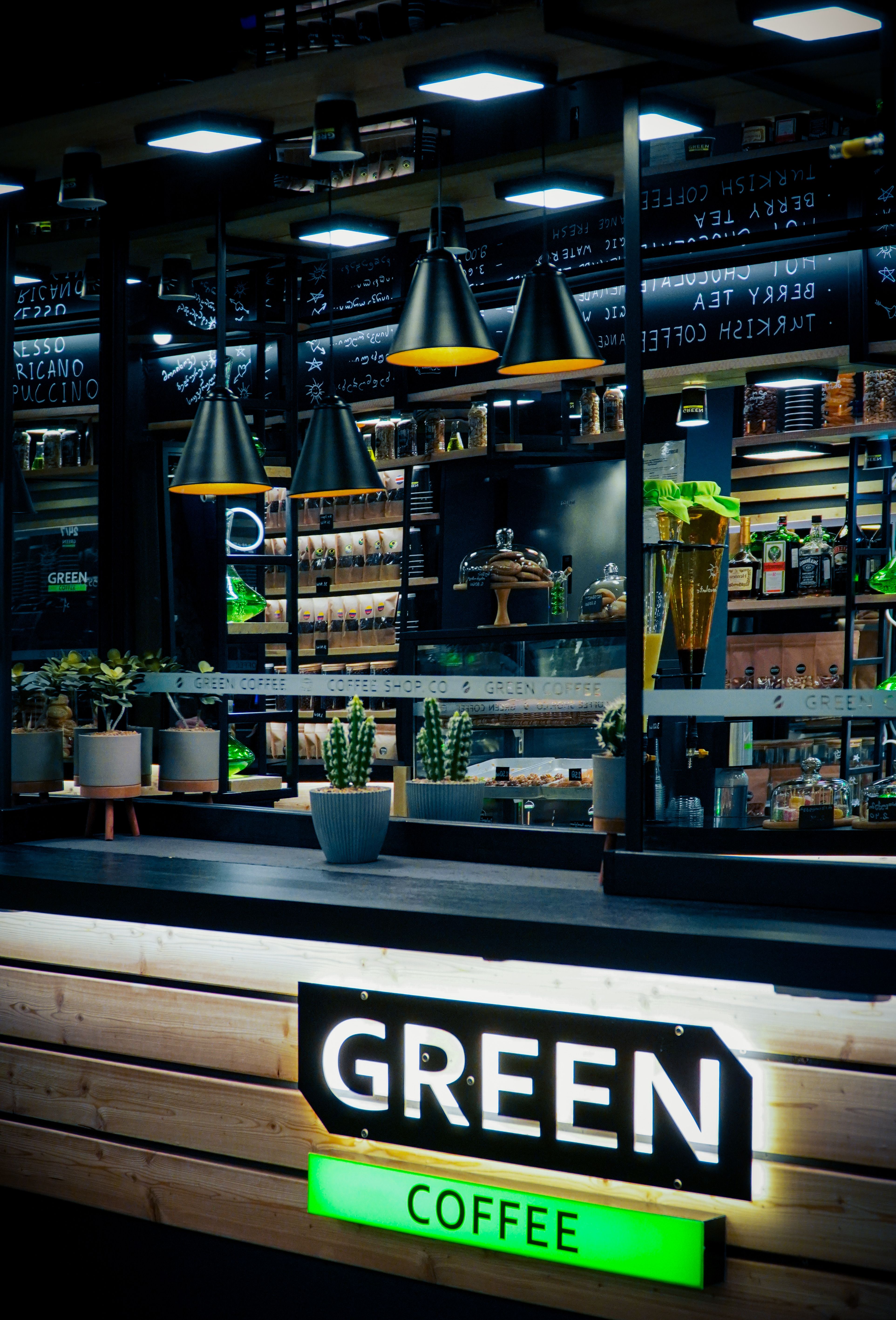 A green coffee shop with a sign that says green coffee · Free Stock Photo