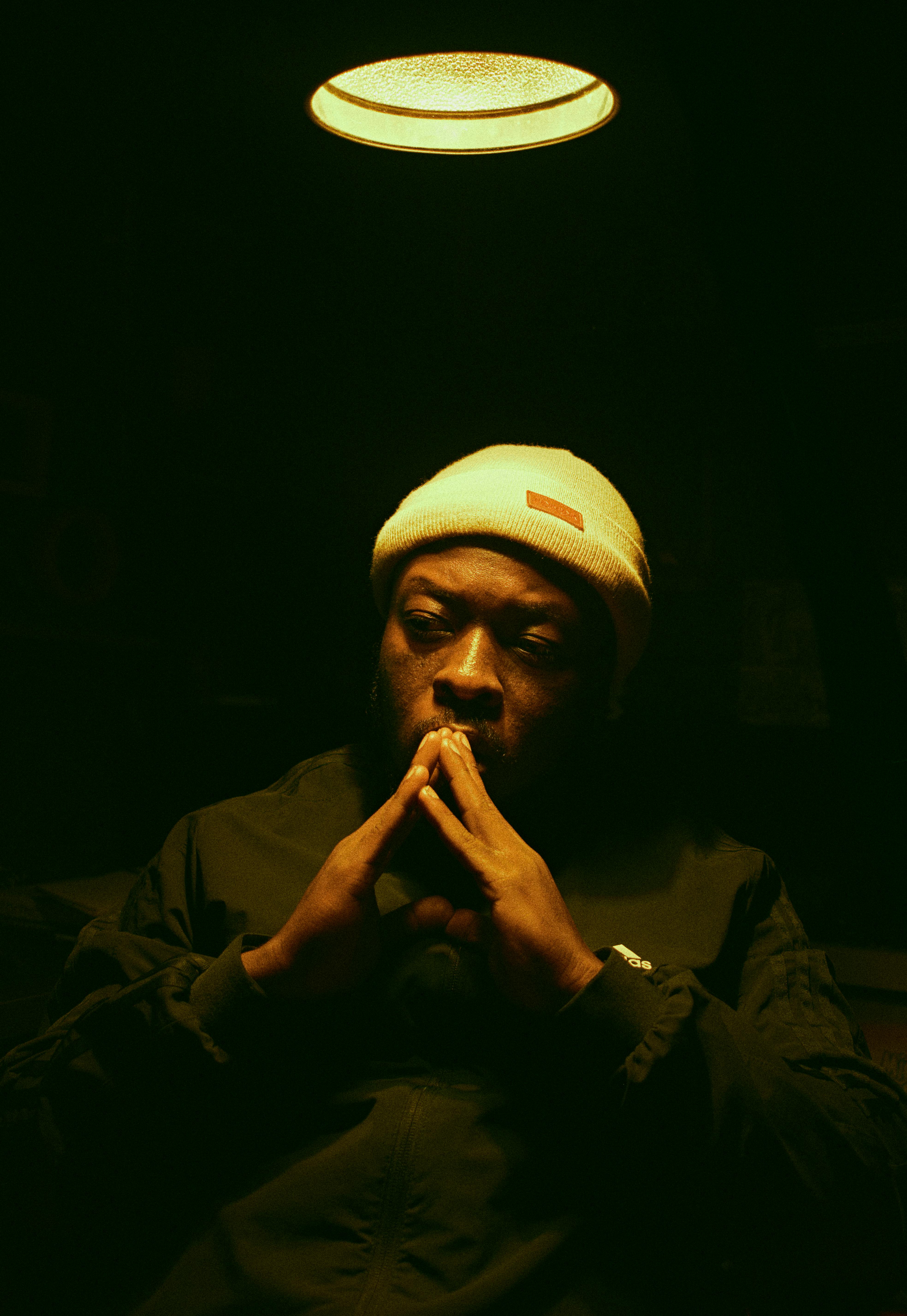 Man sitting under a spotlight · Free Stock Photo