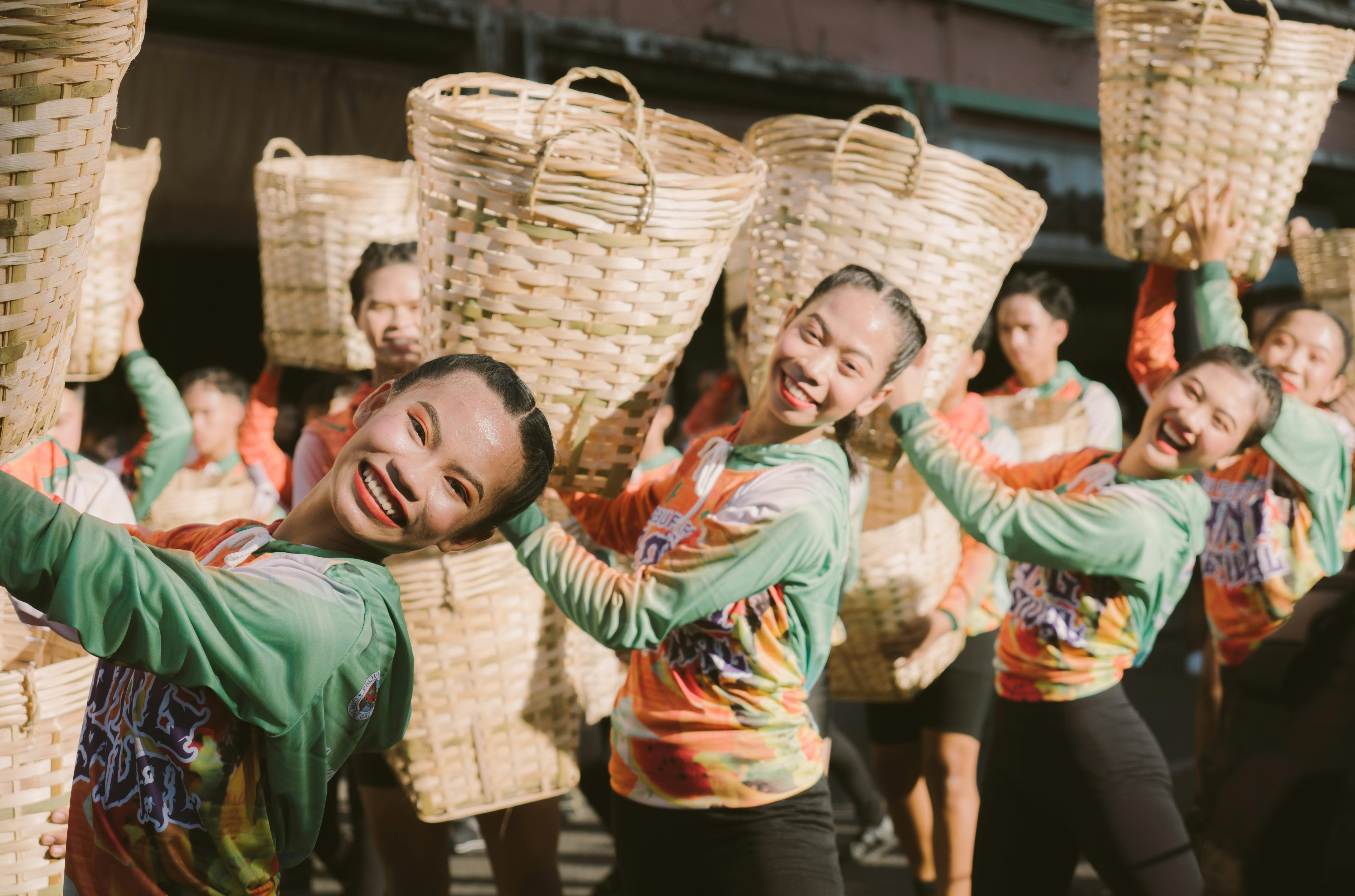 Smiling Girls in Traditional Clothing Carrying Wicker Baskets in Parade ...