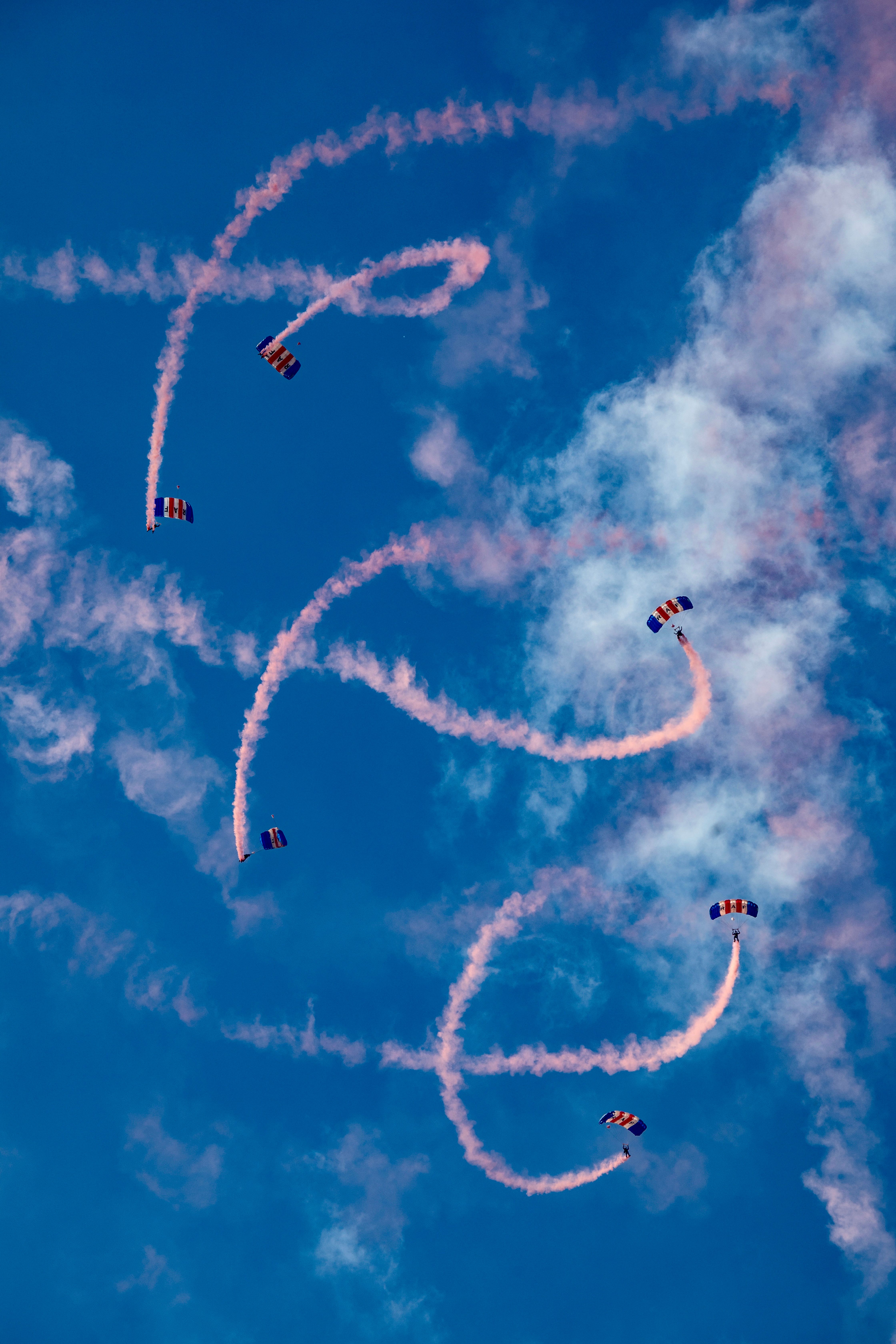 A group of planes flying in the sky with smoke trails · Free Stock Photo