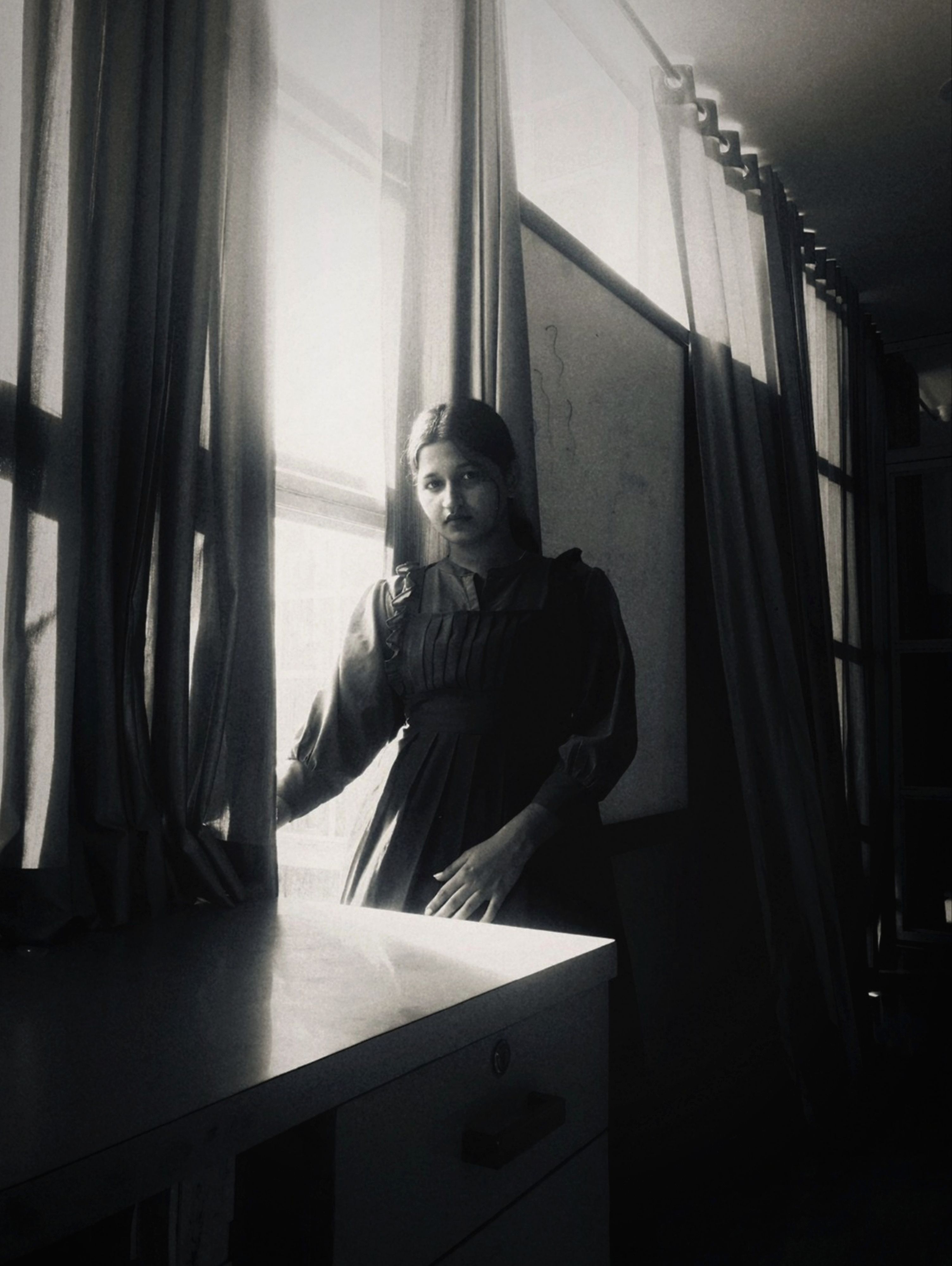Woman Standing near Window in Black and White · Free Stock Photo