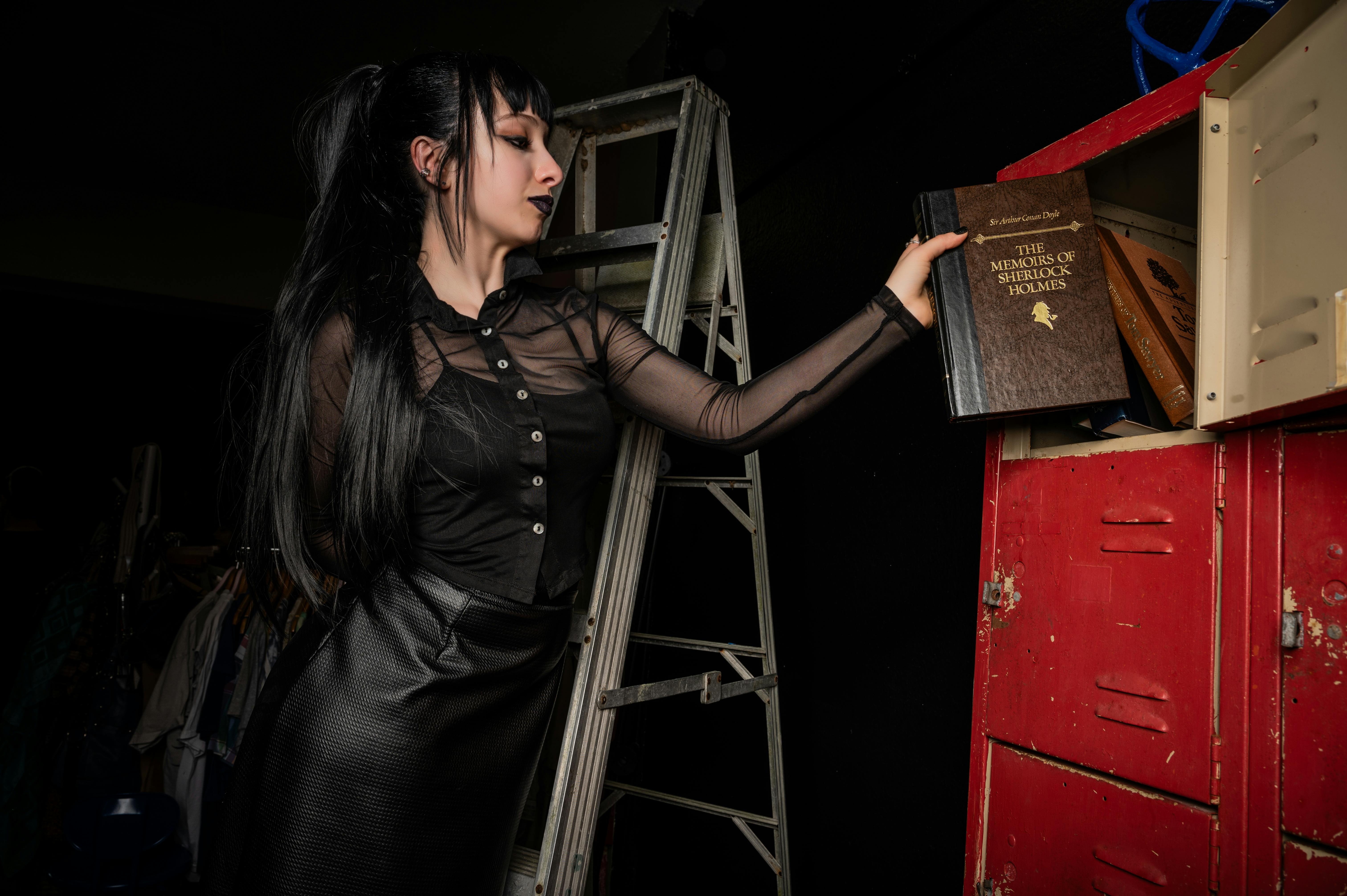 Woman in Dark Outfit Holding a Book · Free Stock Photo