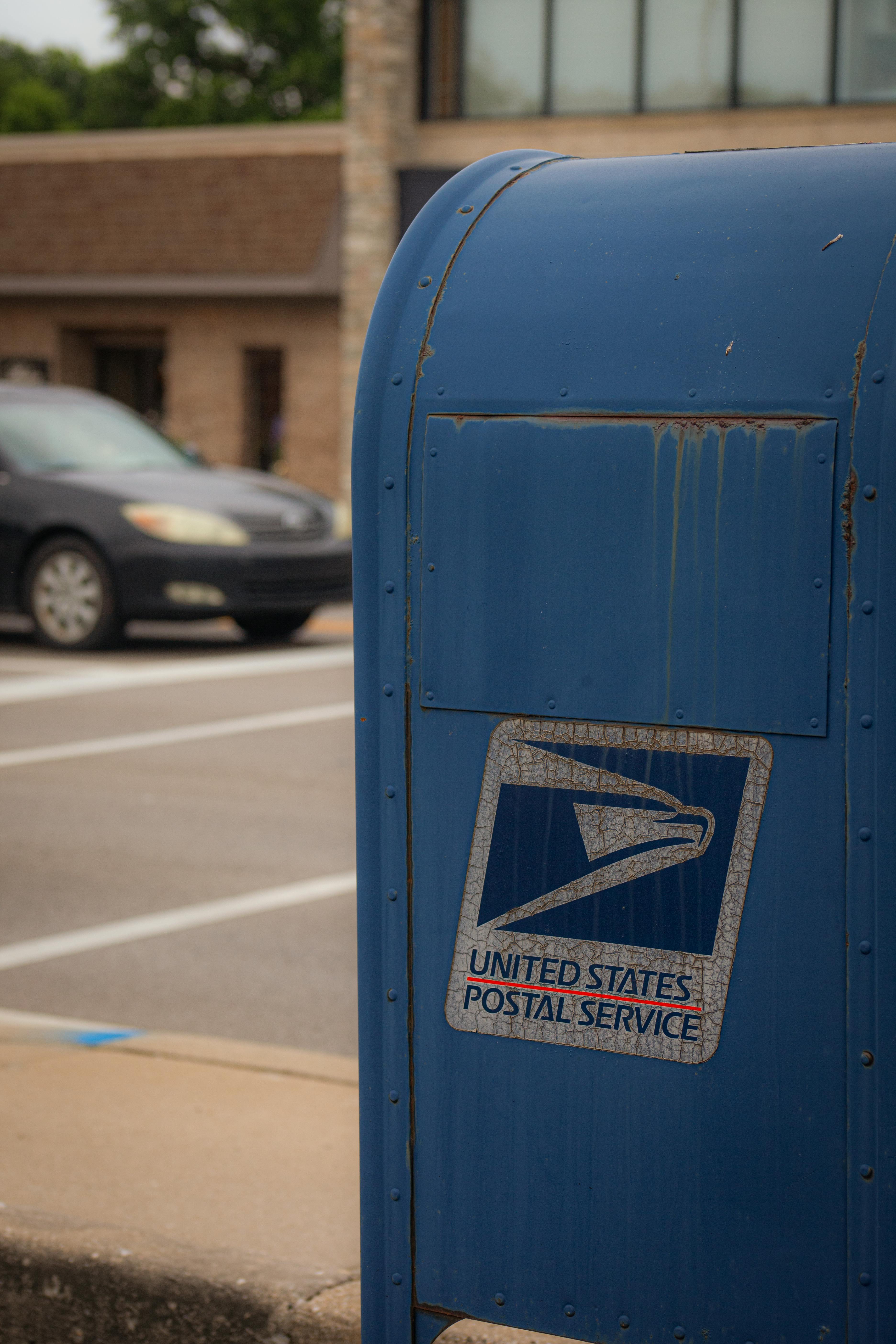 A blue post box with a blue usps logo on it · Free Stock Photo