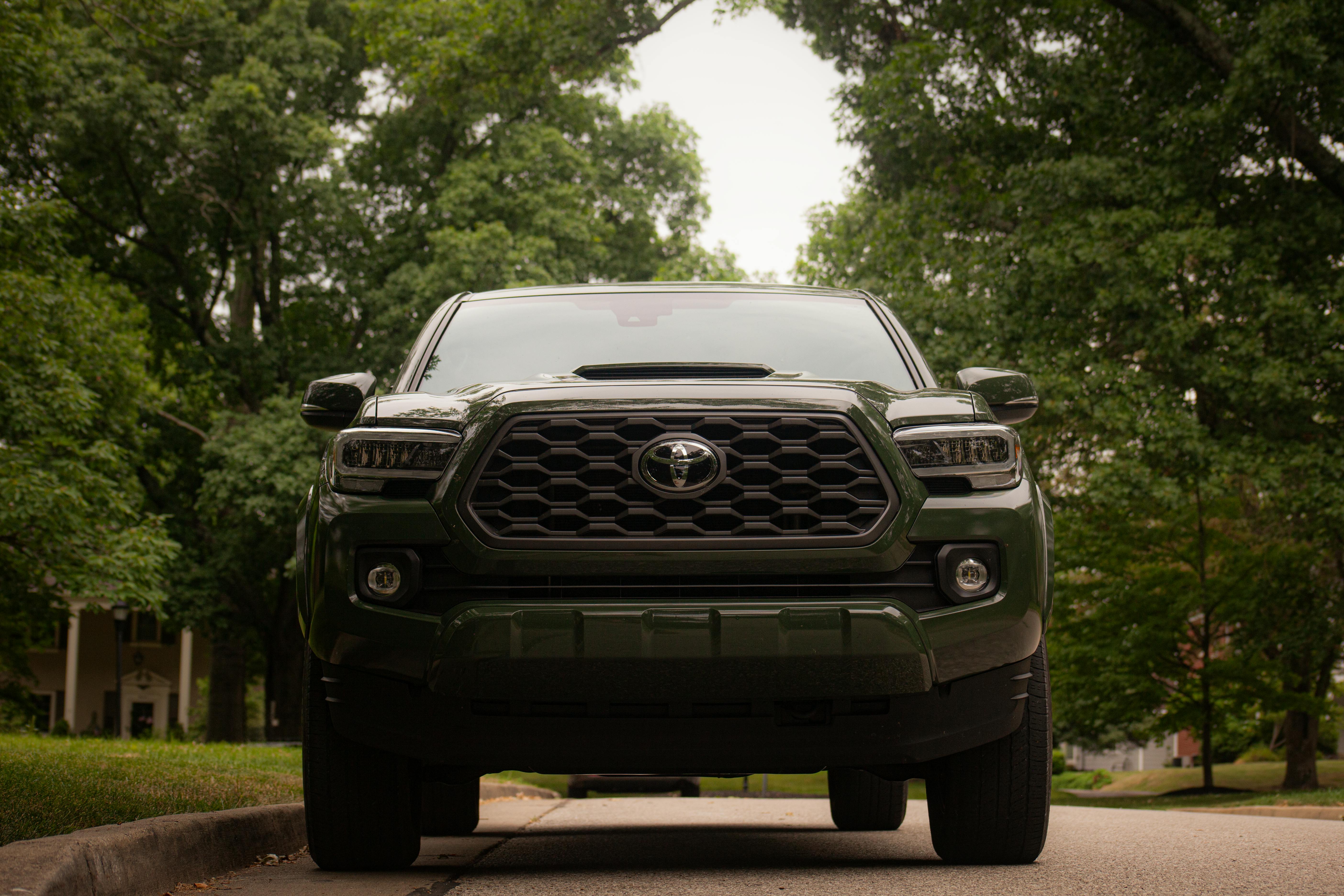 The front end of a green toyota tacoma · Free Stock Photo