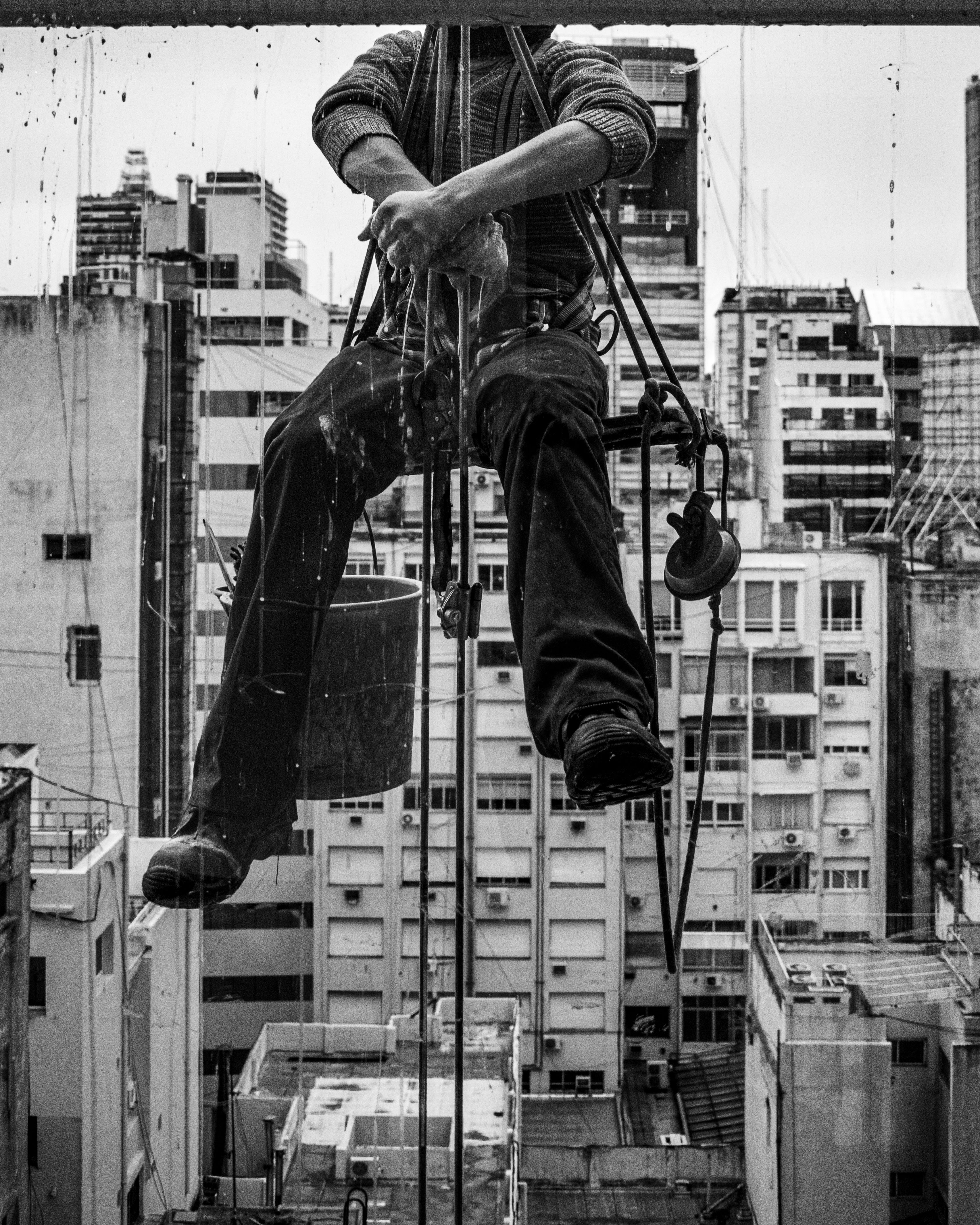 Man Cleaning Windows in Black and White · Free Stock Photo