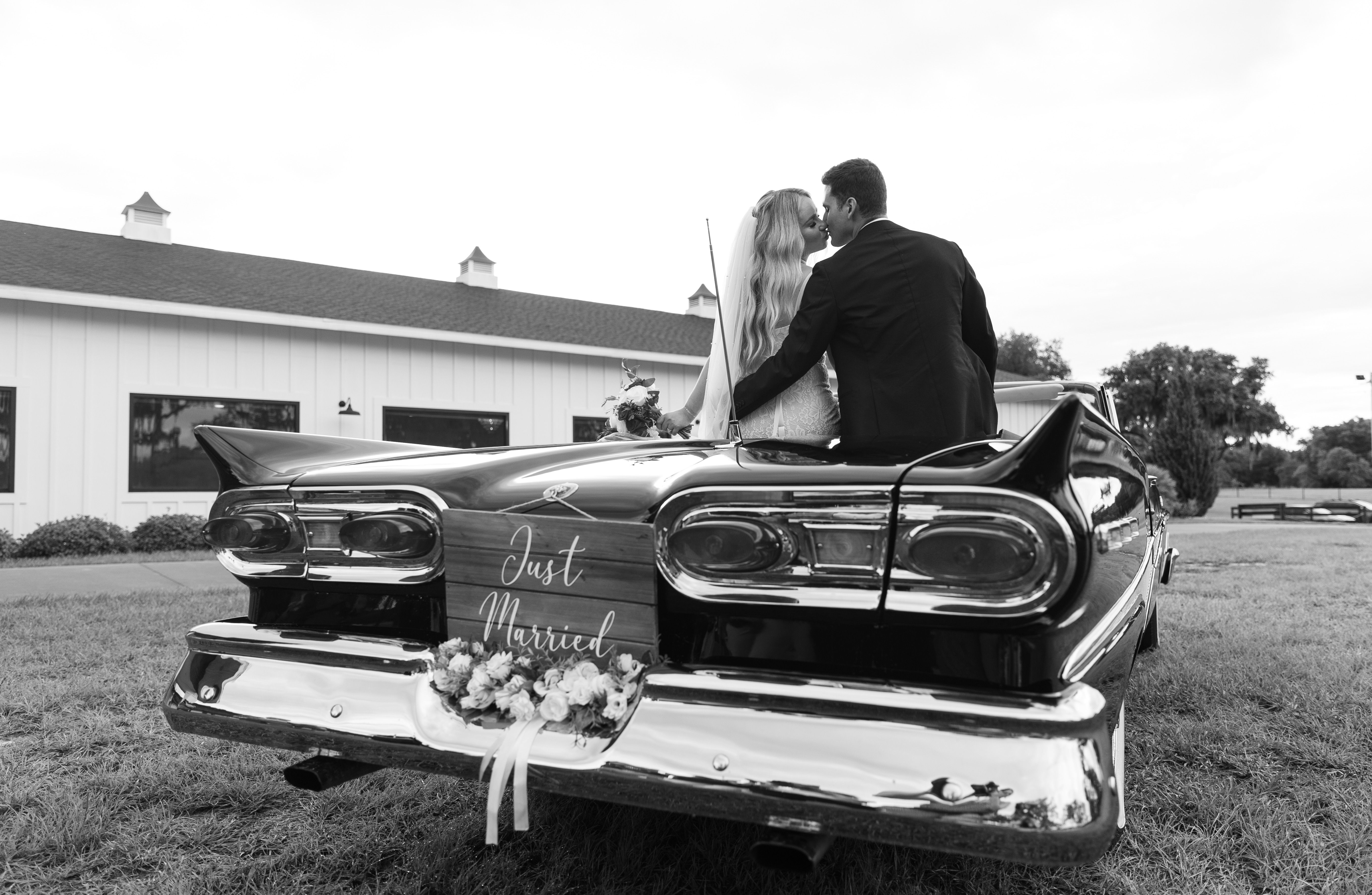 Newlyweds Sitting and Kissing in Car in Black and White · Free Stock Photo