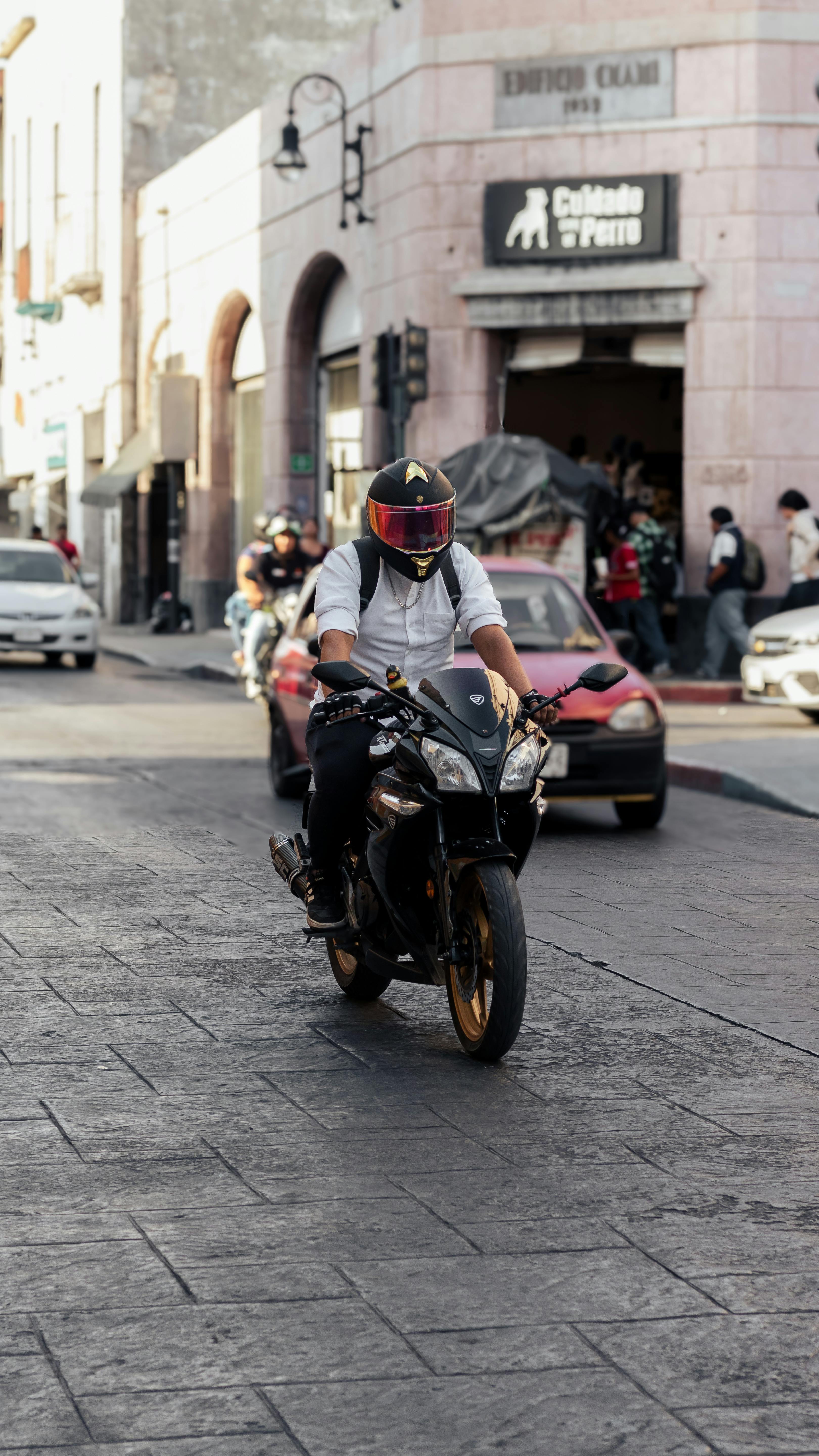 Person Riding on Yellow Motor Scooter on Road · Free Stock Photo