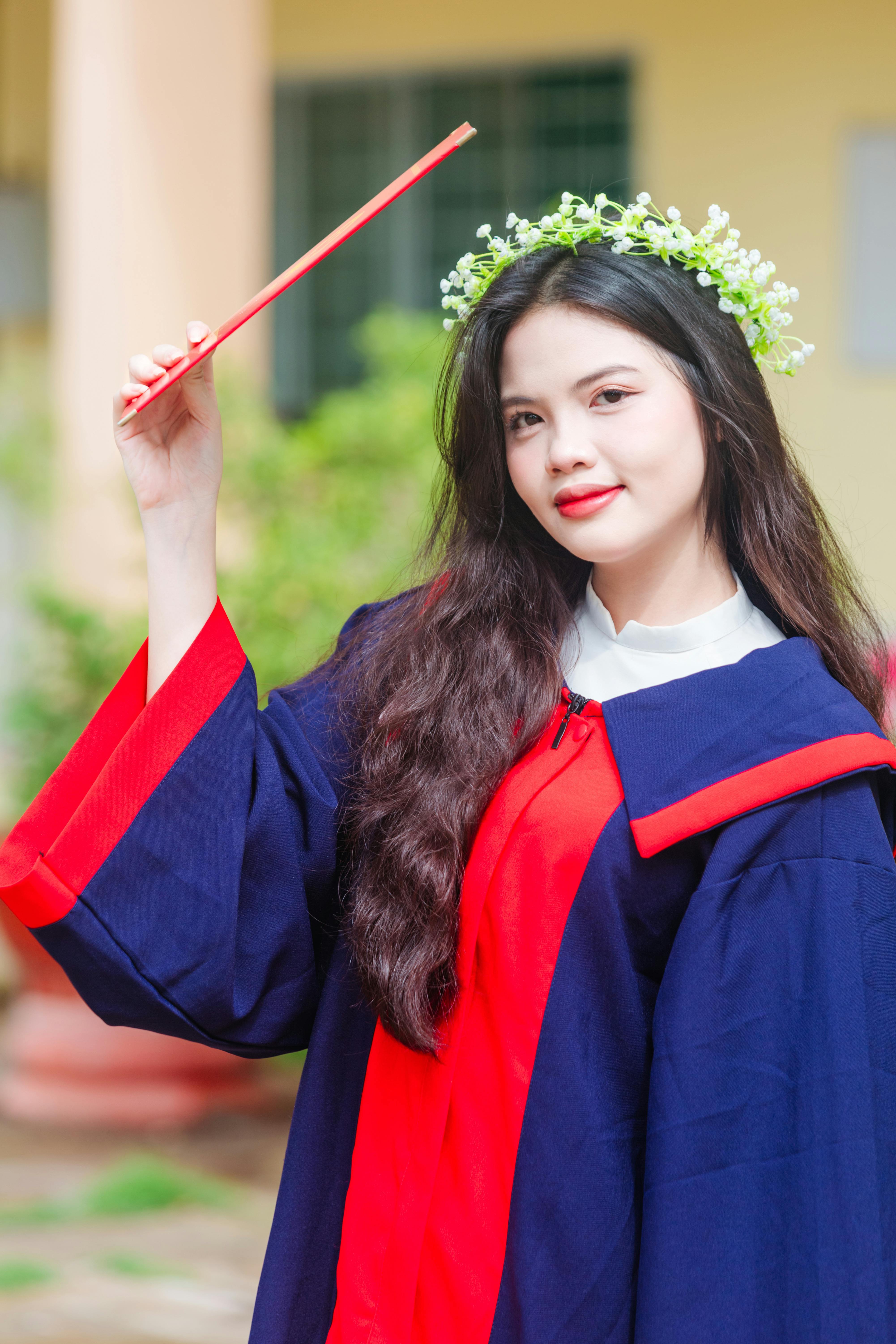 Gorgeous Woman Wearing Graduation Toga Posing · Free Stock Photo