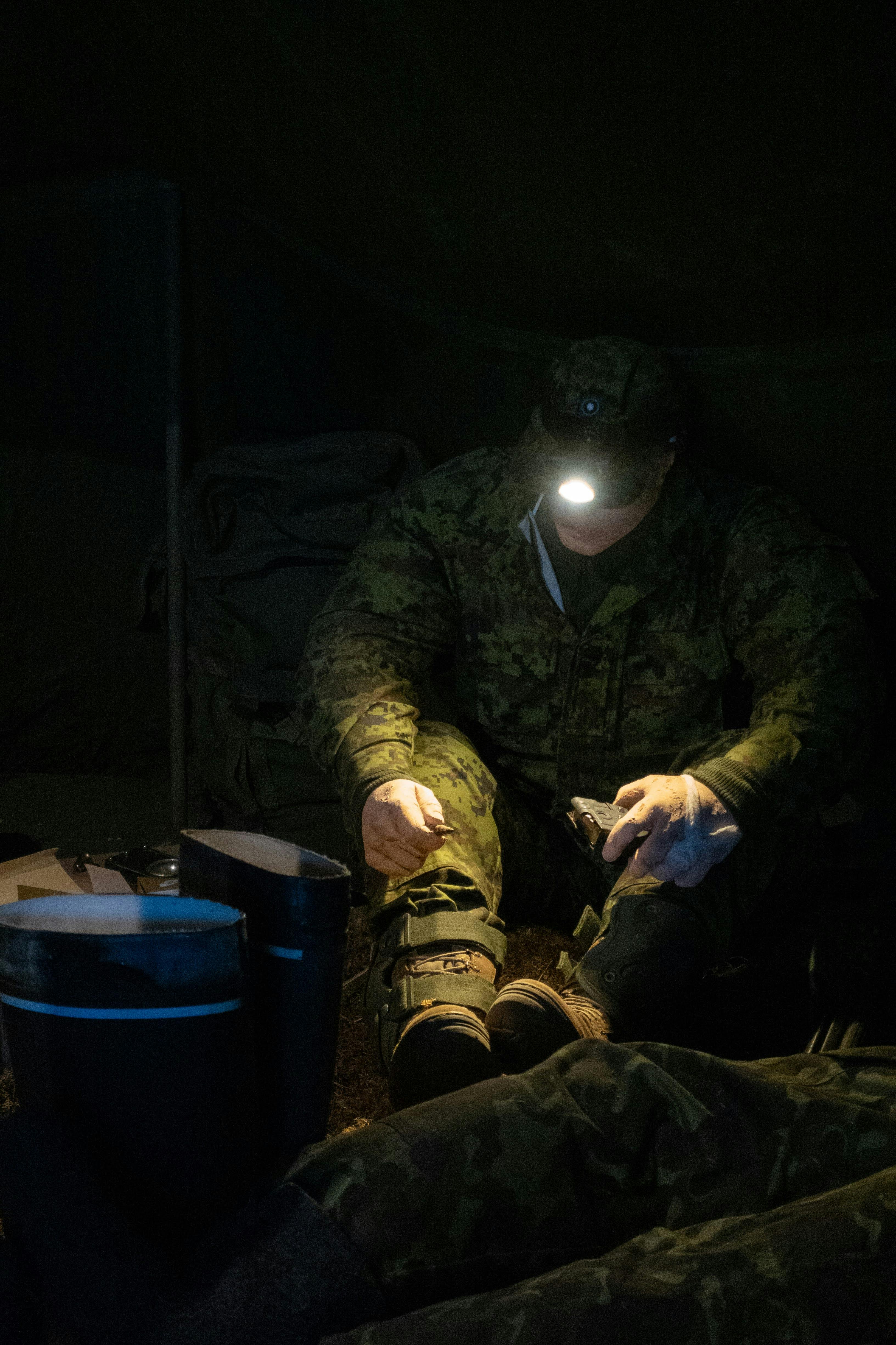 Soldier Loading a Mag in the Light of a Headlamp · Free Stock Photo