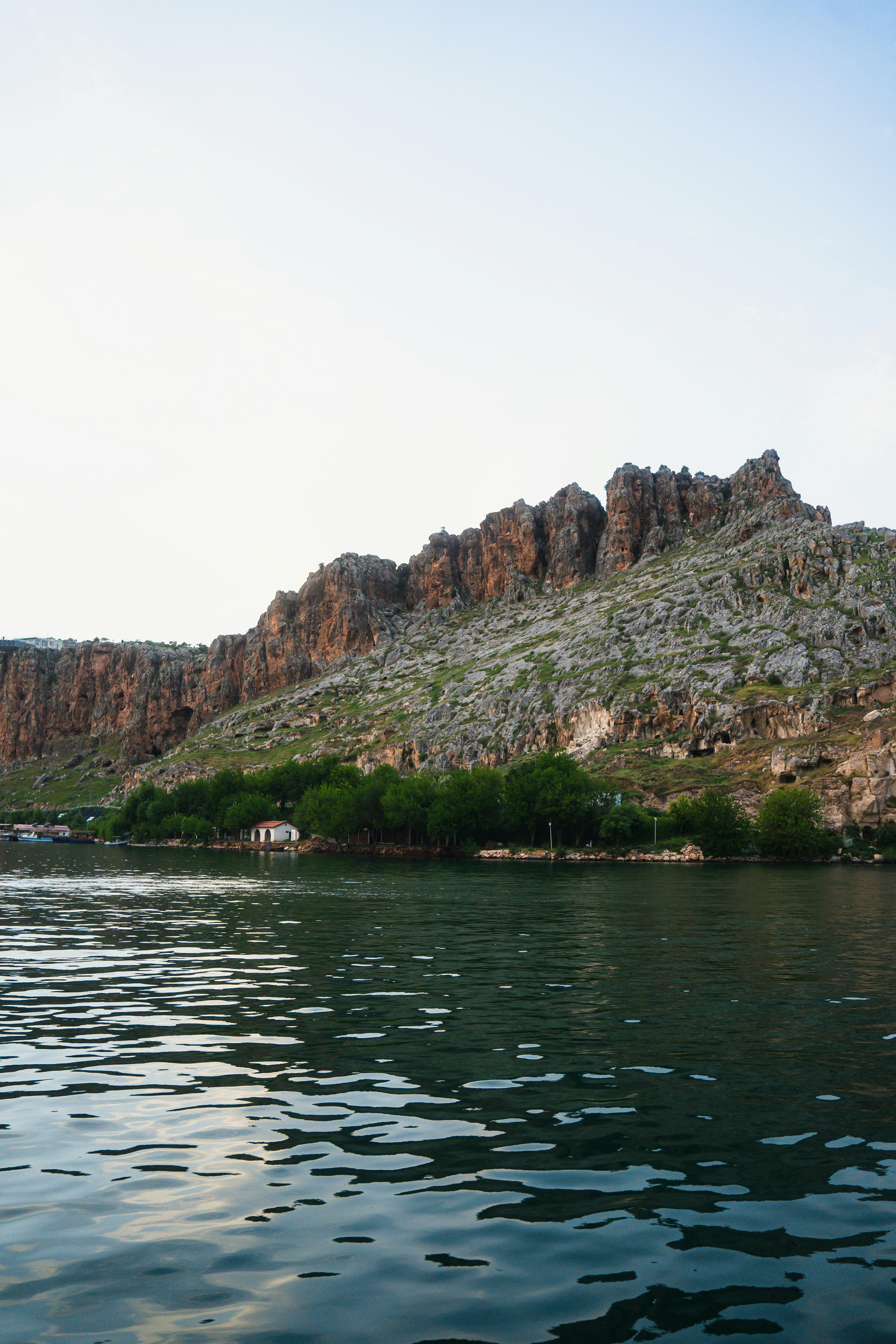 Scenic Rocky Cliff by Tranquil Lakeside · Free Stock Photo