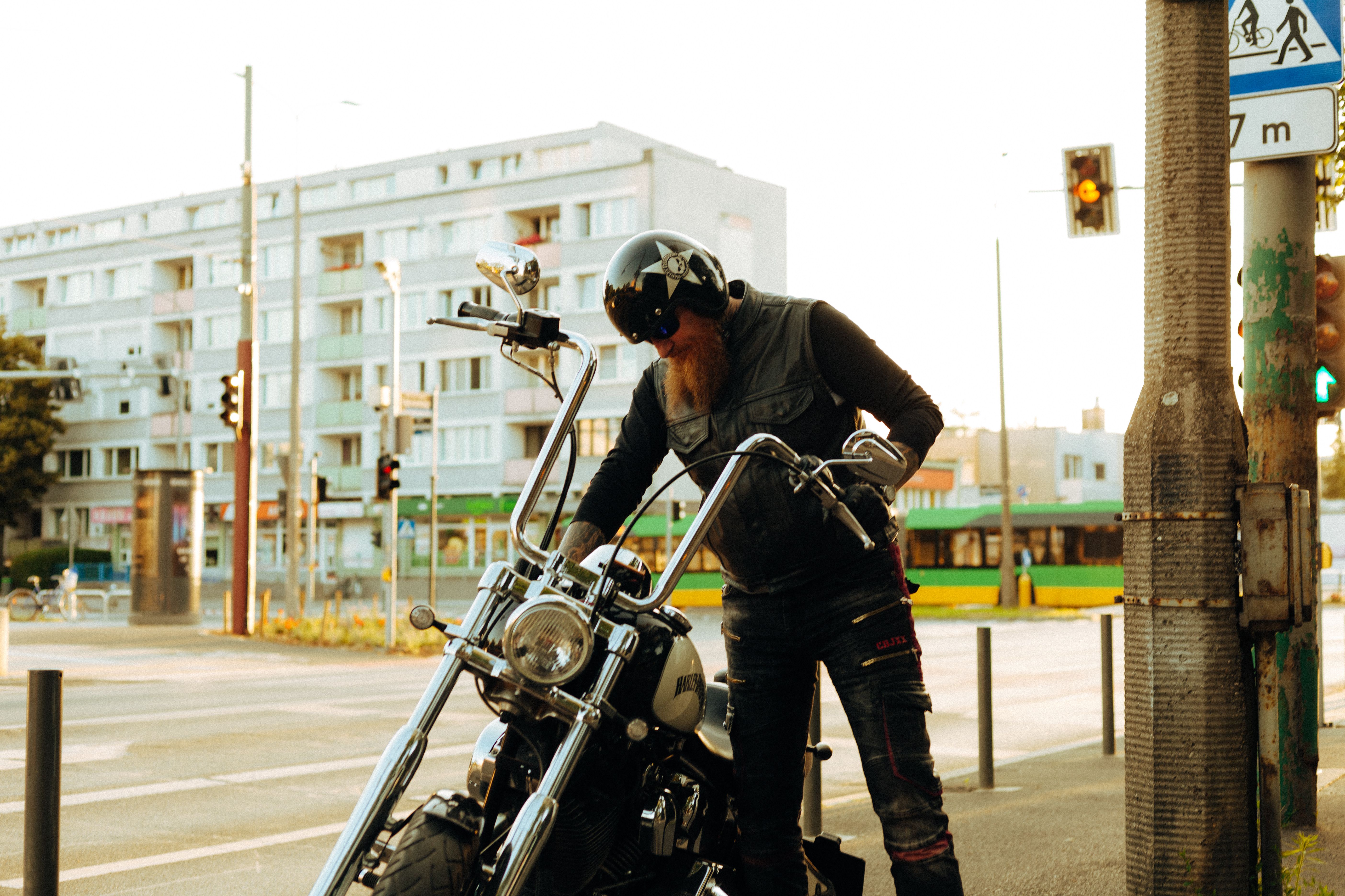 Bearded Biker Standing by a Motorcycle Parked on the Street · Free ...