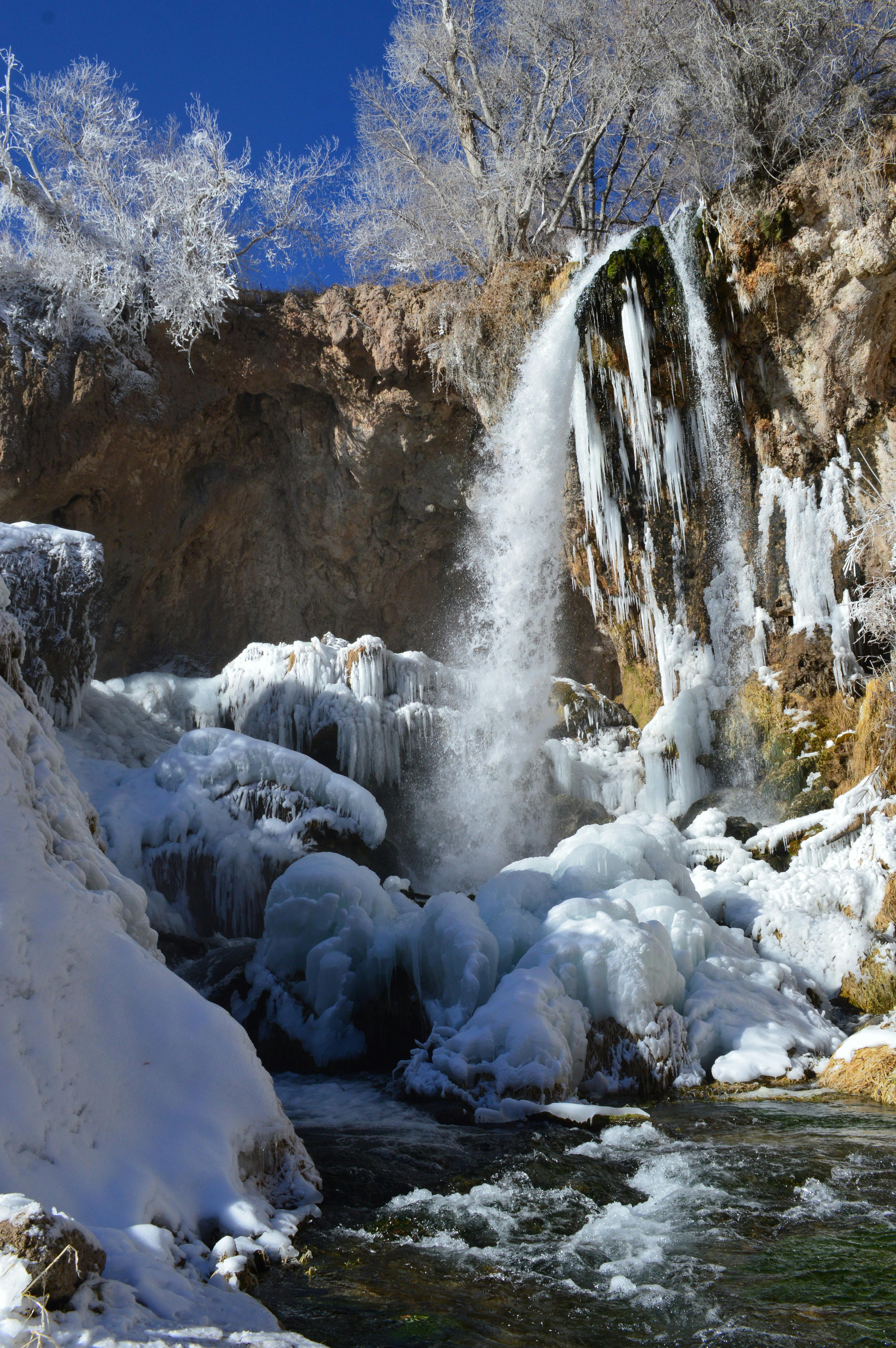 Snow Dropping From a Cliff · Free Stock Photo
