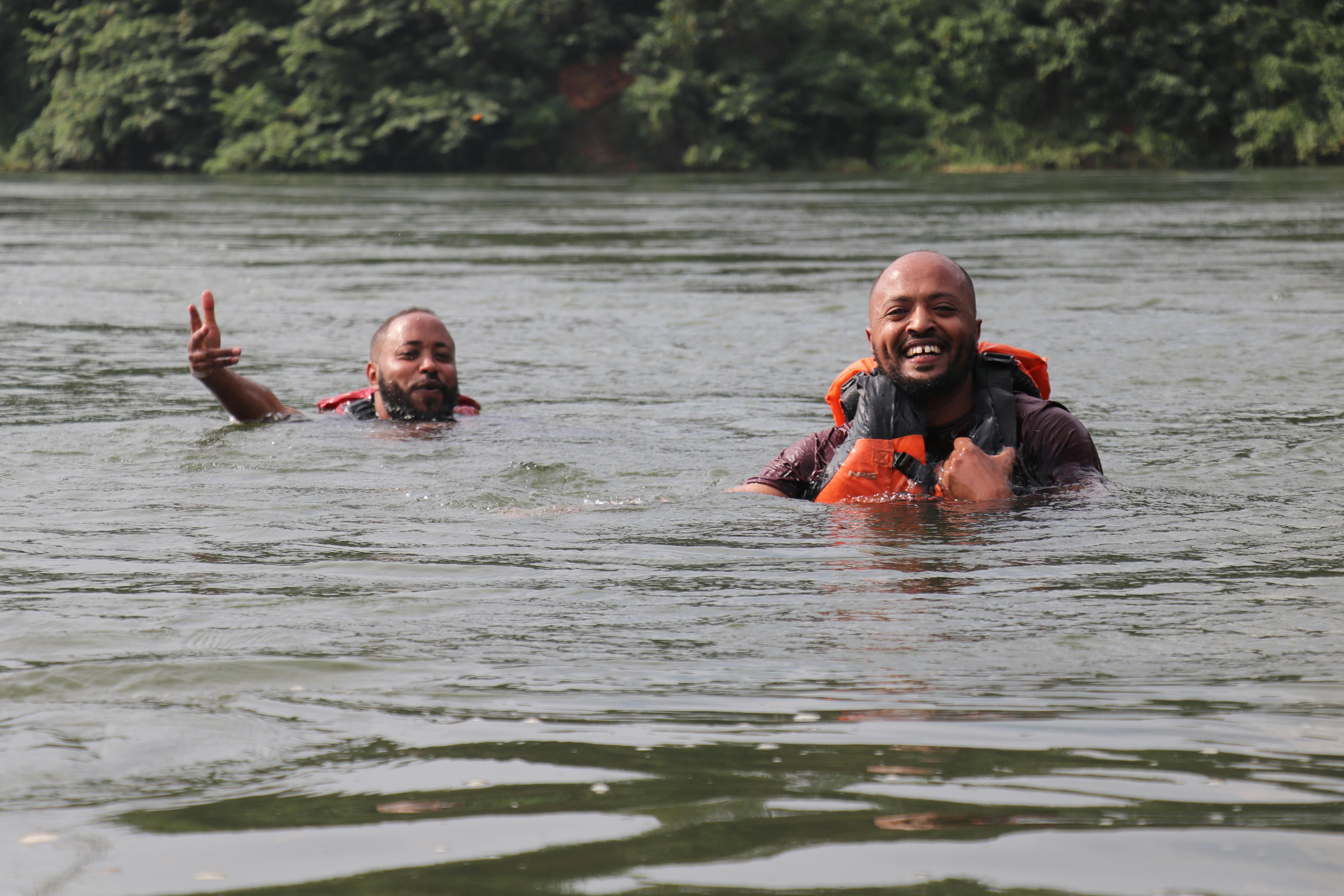 Men in Life Jackets Swimming in the River · Free Stock Photo