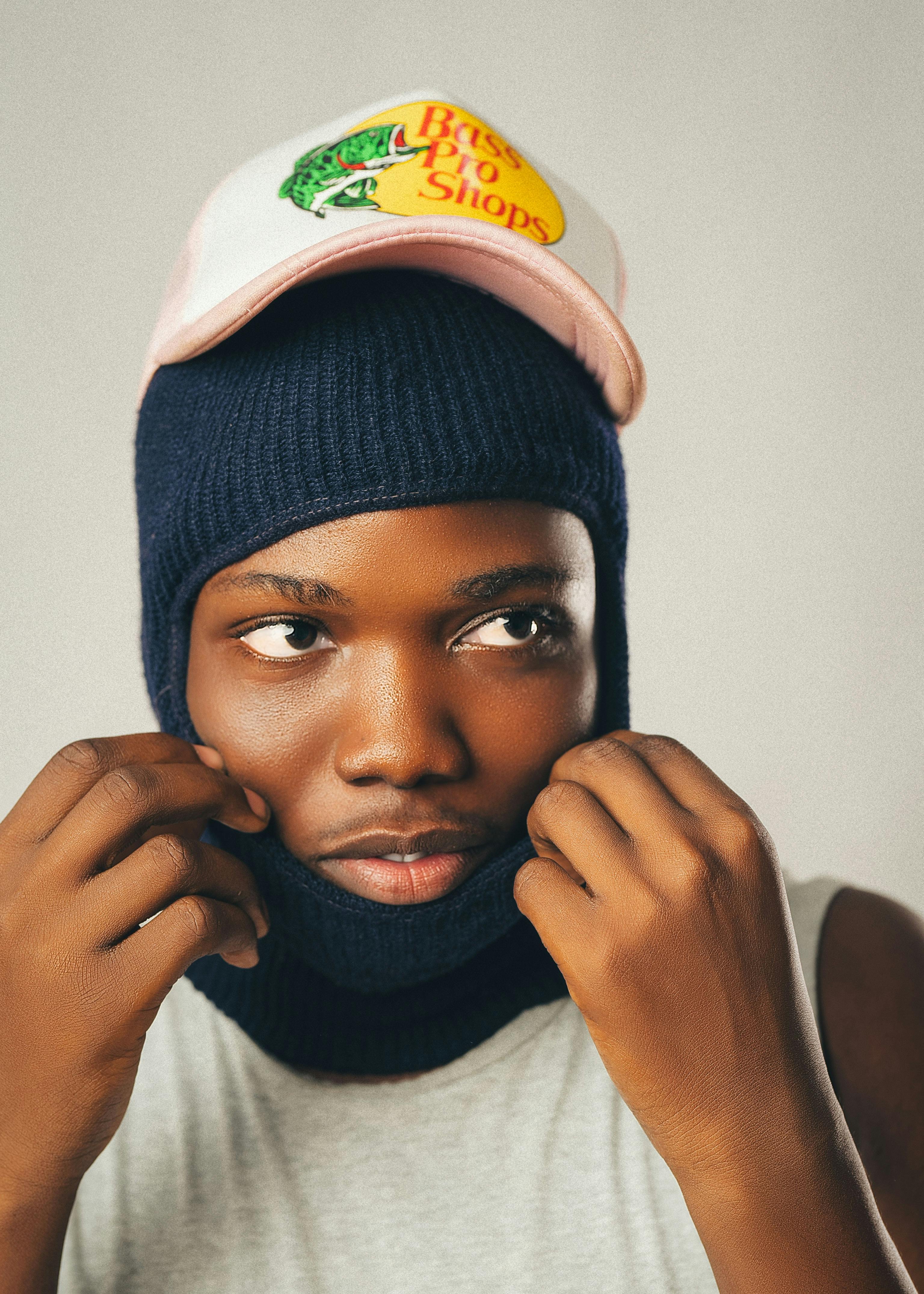 Portrait of a Young Man Wearing a Balaclava and a Pink Baseball Cap ...