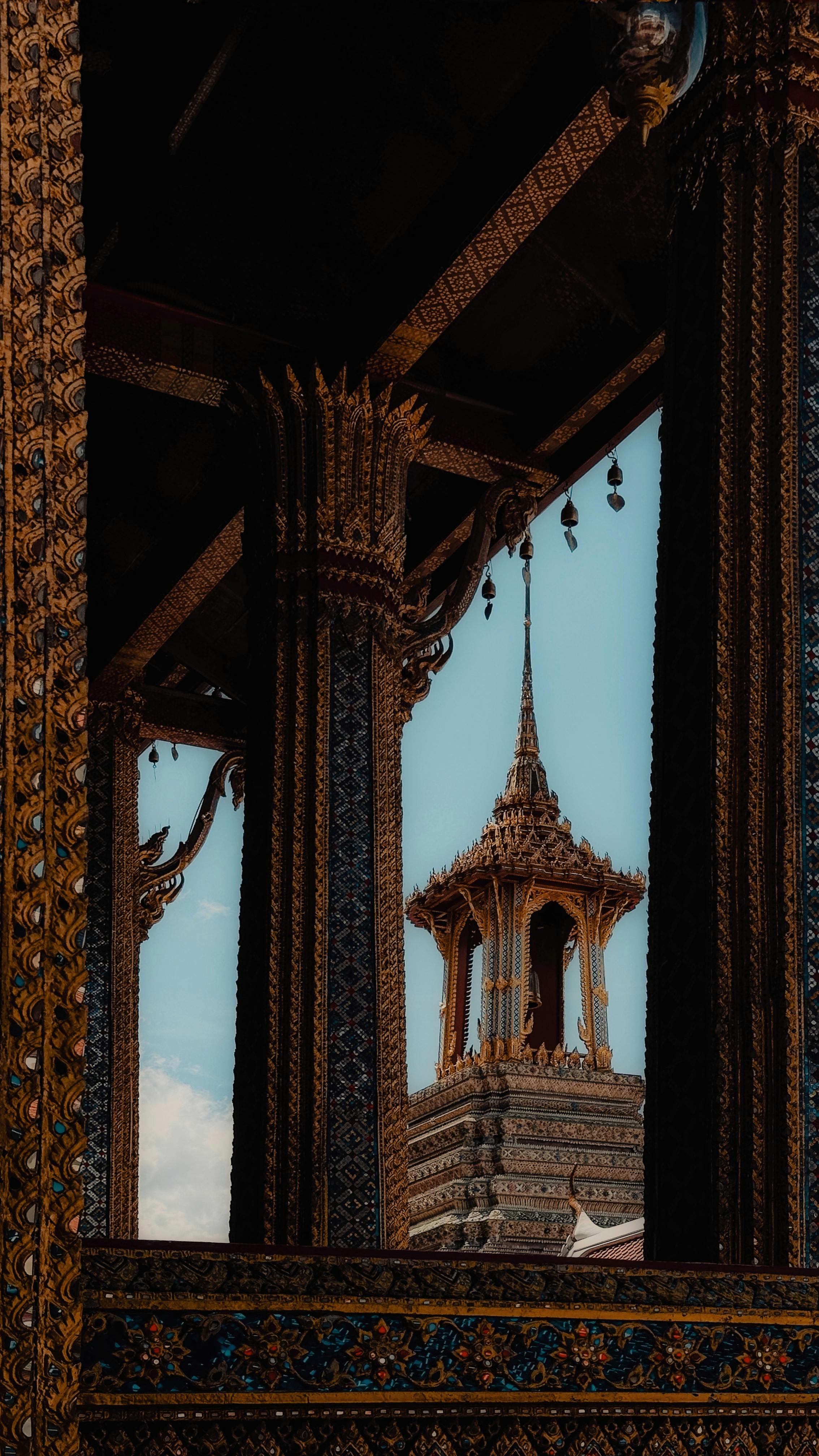 Tower behind Temple Windows and Column · Free Stock Photo