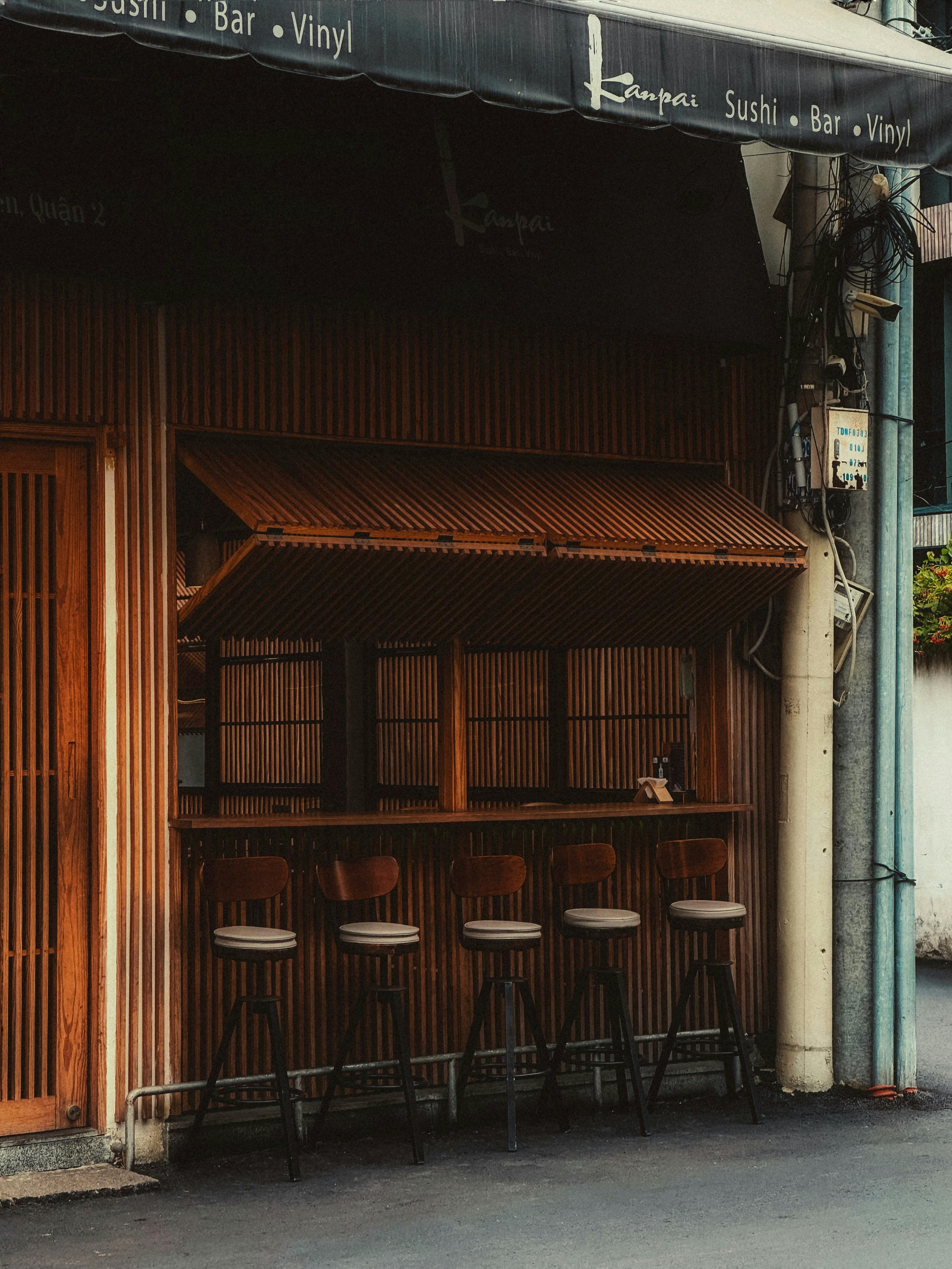 Empty Chairs by the Counter of a Sushi Bar · Free Stock Photo