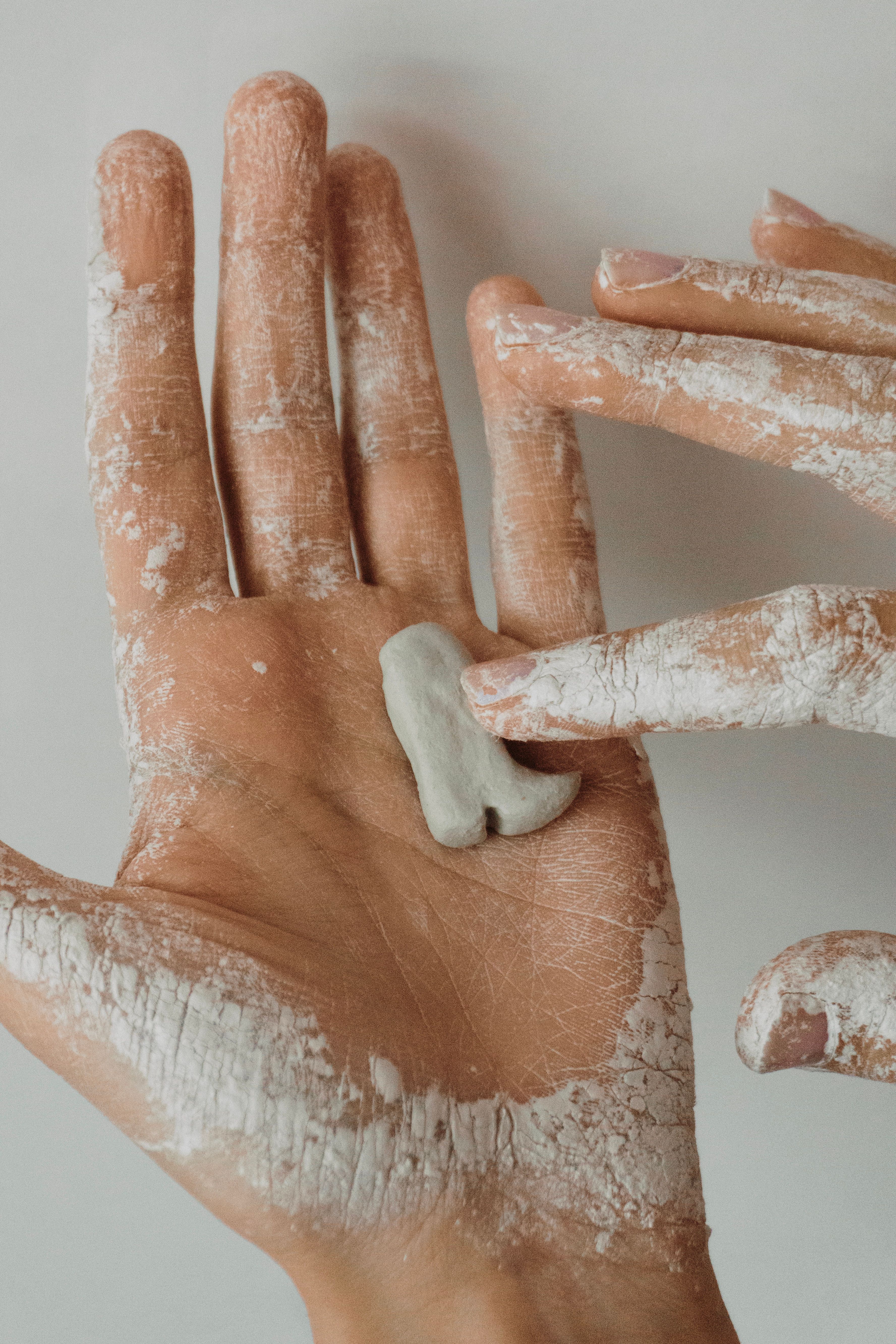 Person Rubbing Lotion onto Hand · Free Stock Photo