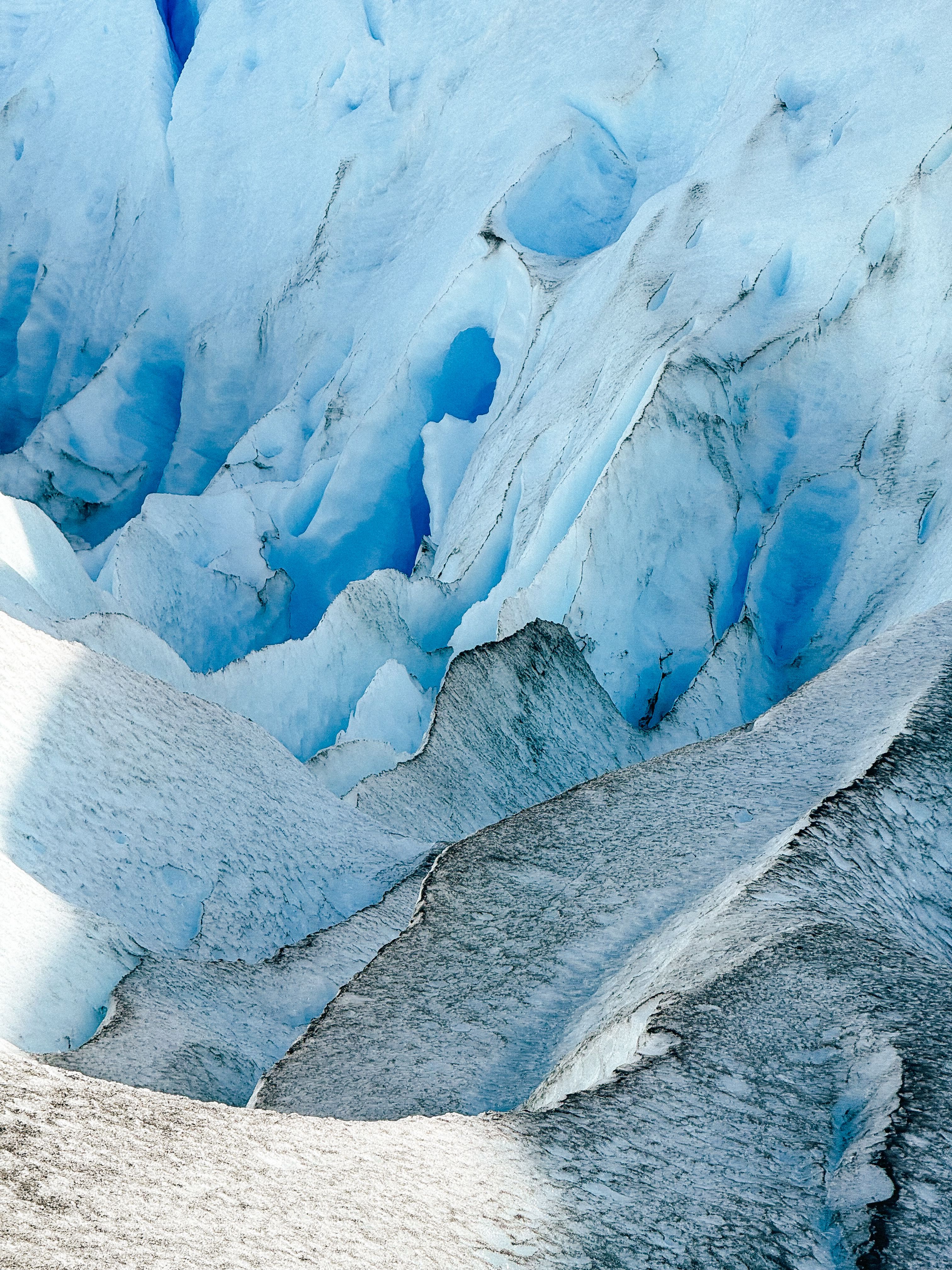 A close up view of a glacier with blue ice · Free Stock Photo