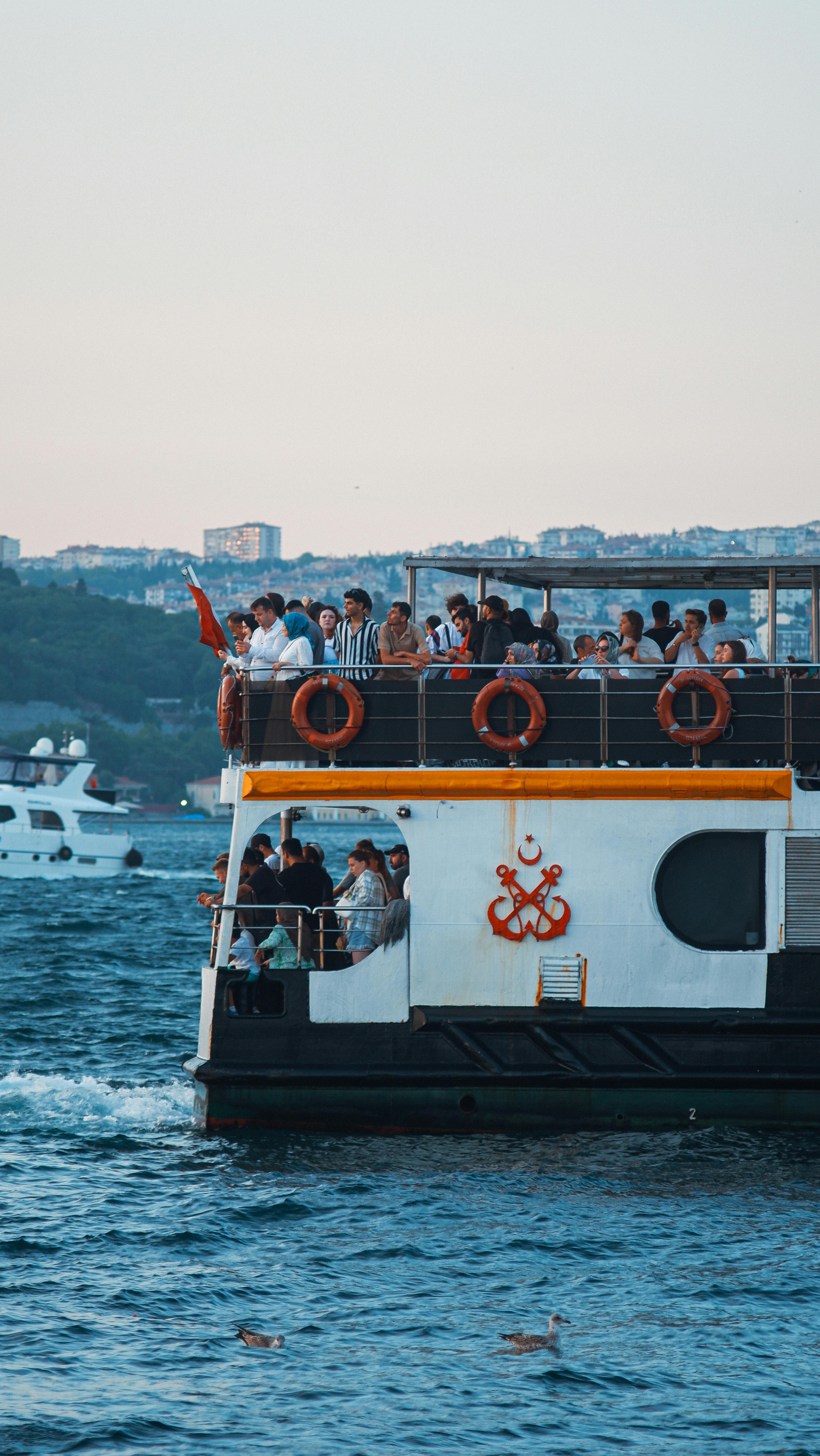 Group of People on Swimming Ferry Cruise Deck · Free Stock Photo