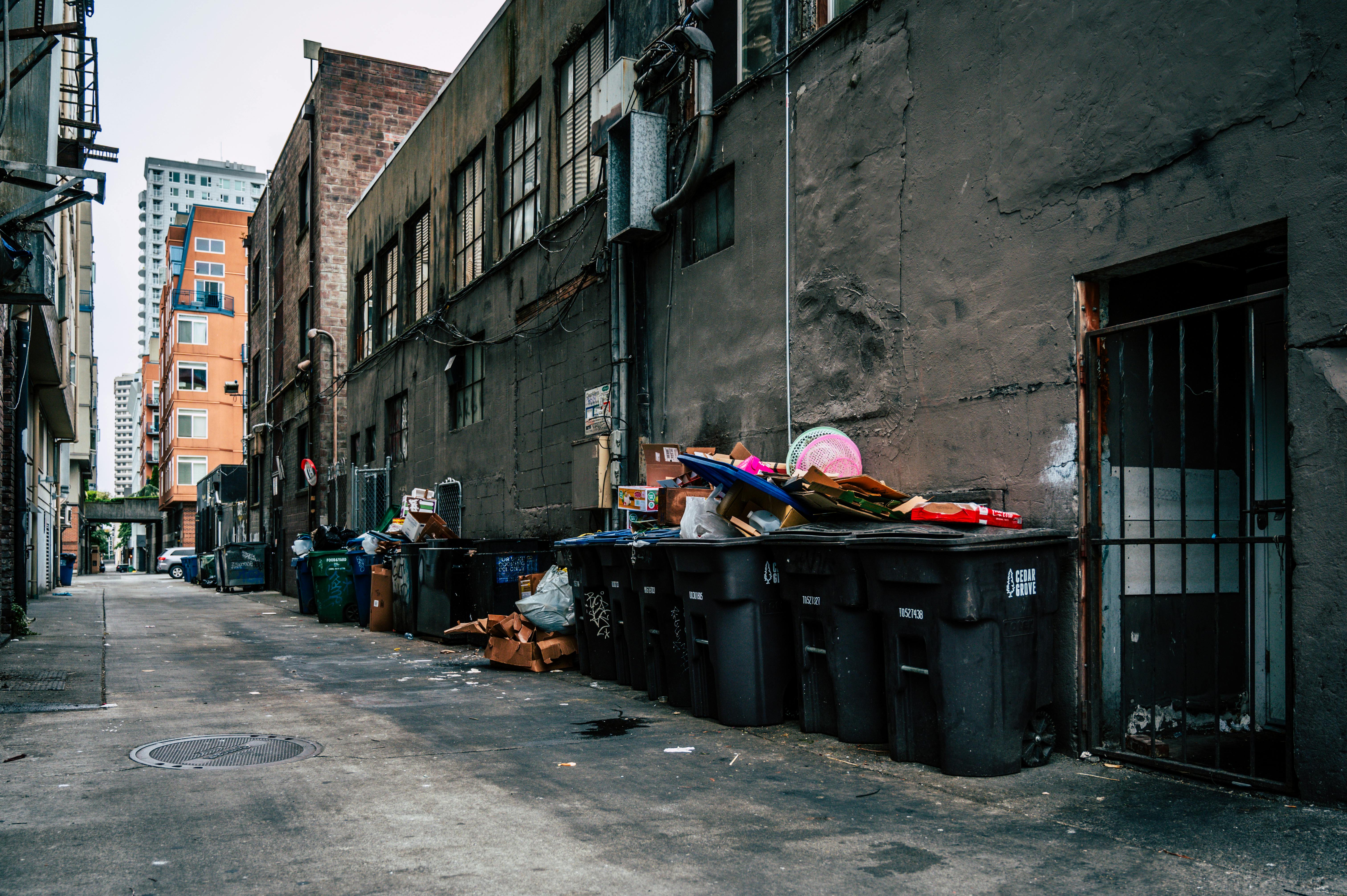 A person laying on the ground in a alley · Free Stock Photo