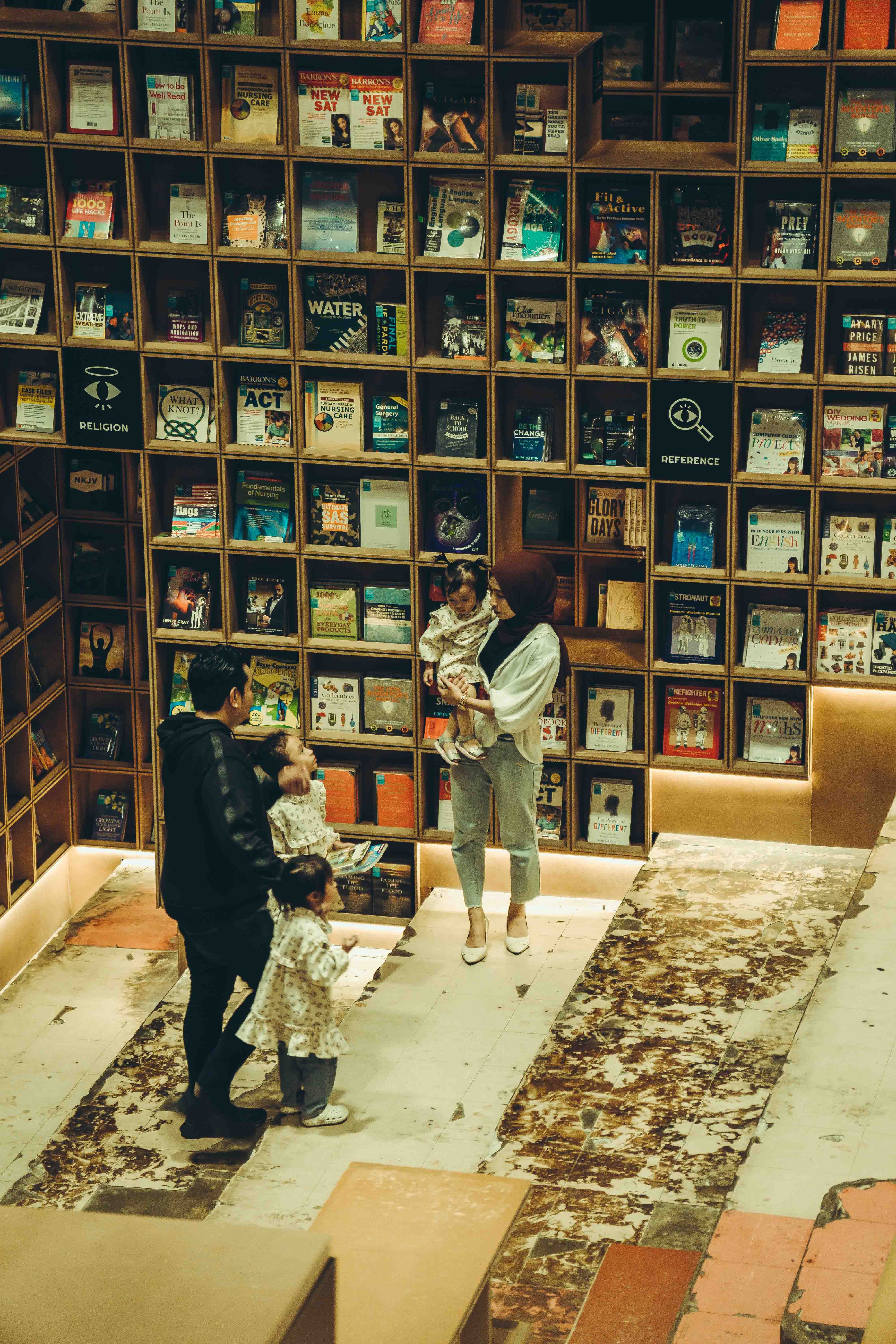 Mother and Father with Children at Library · Free Stock Photo