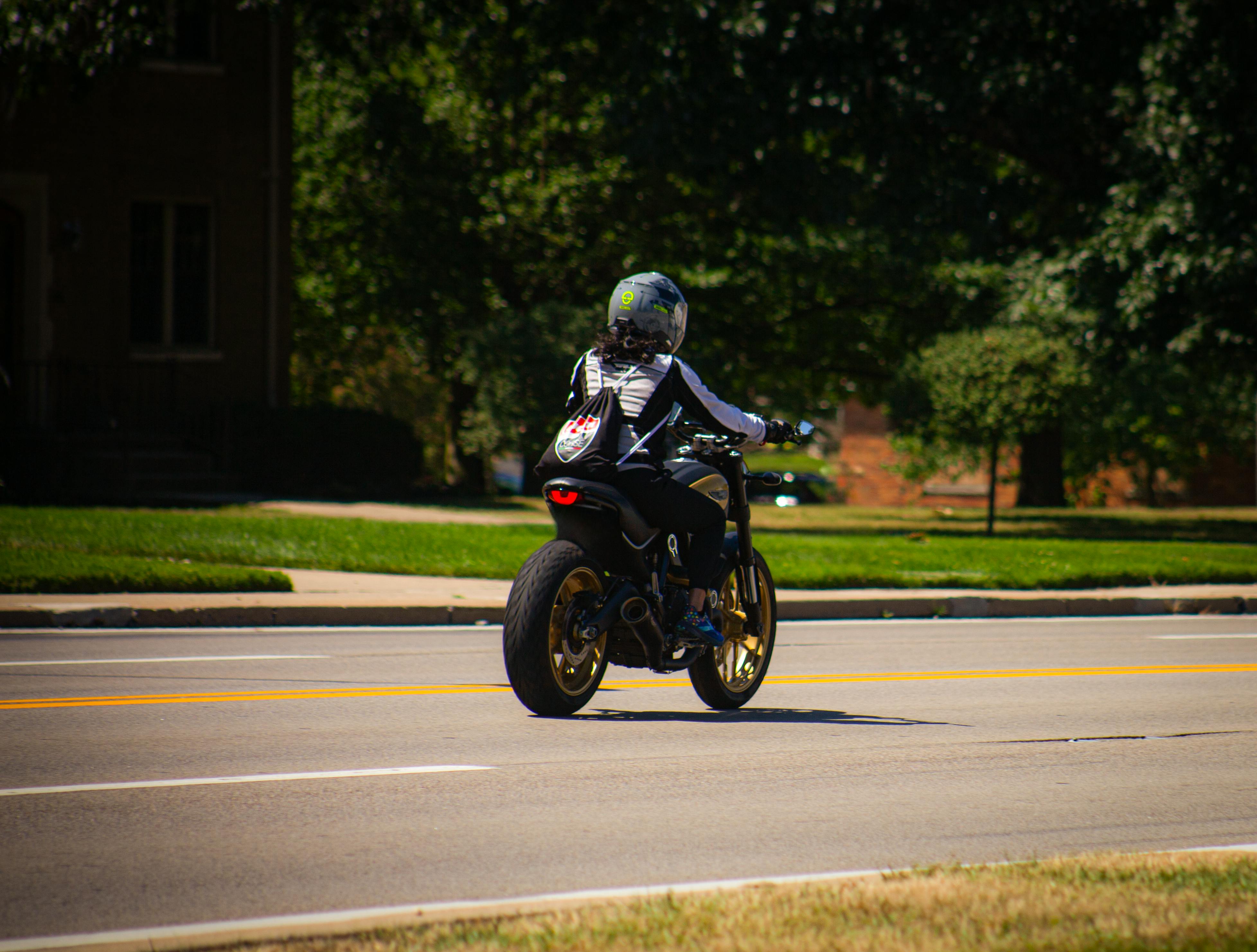 Person Riding Motorcycle on Street · Free Stock Photo