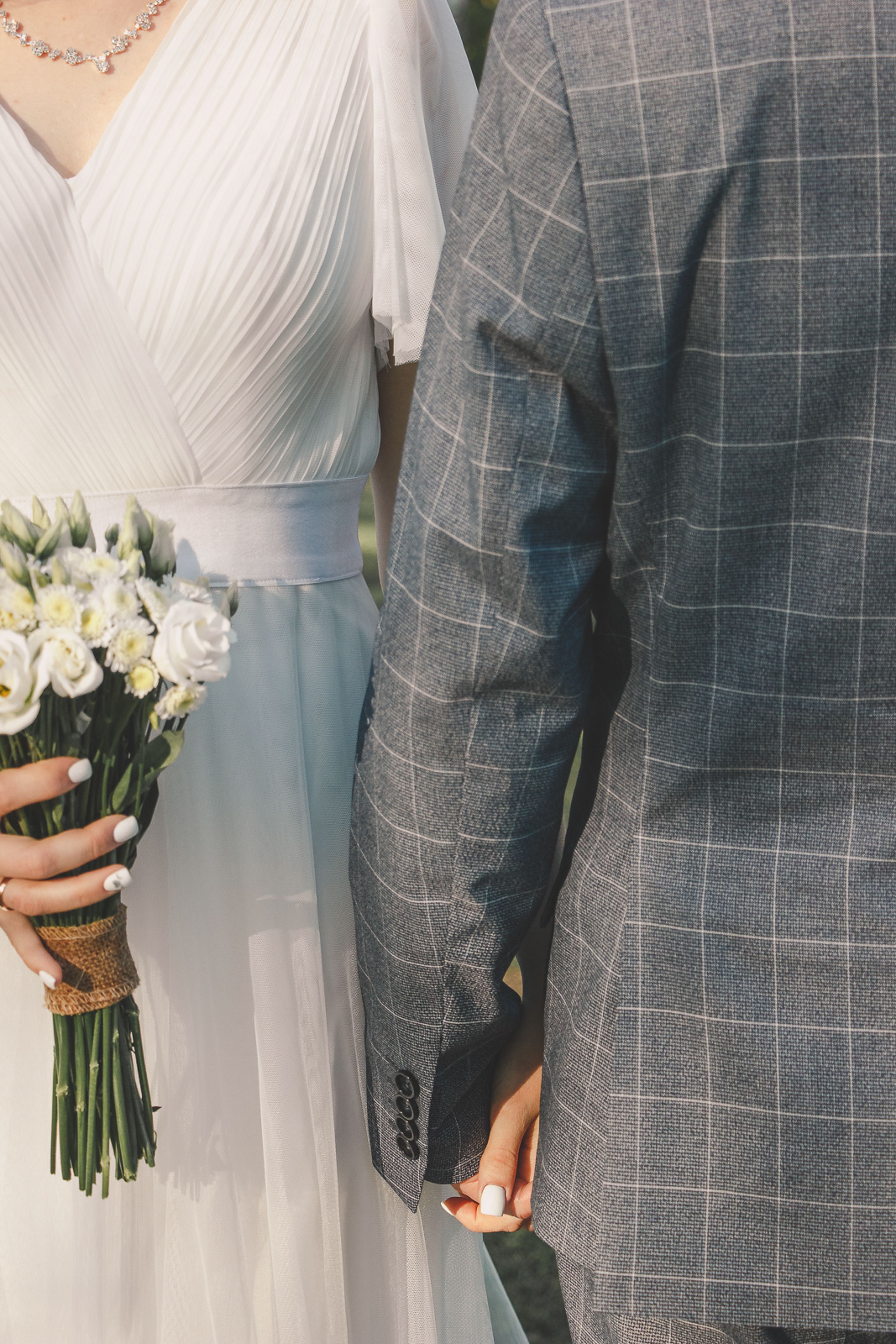 Close-up of the Bride and Groom Standing Close Together and Holding ...