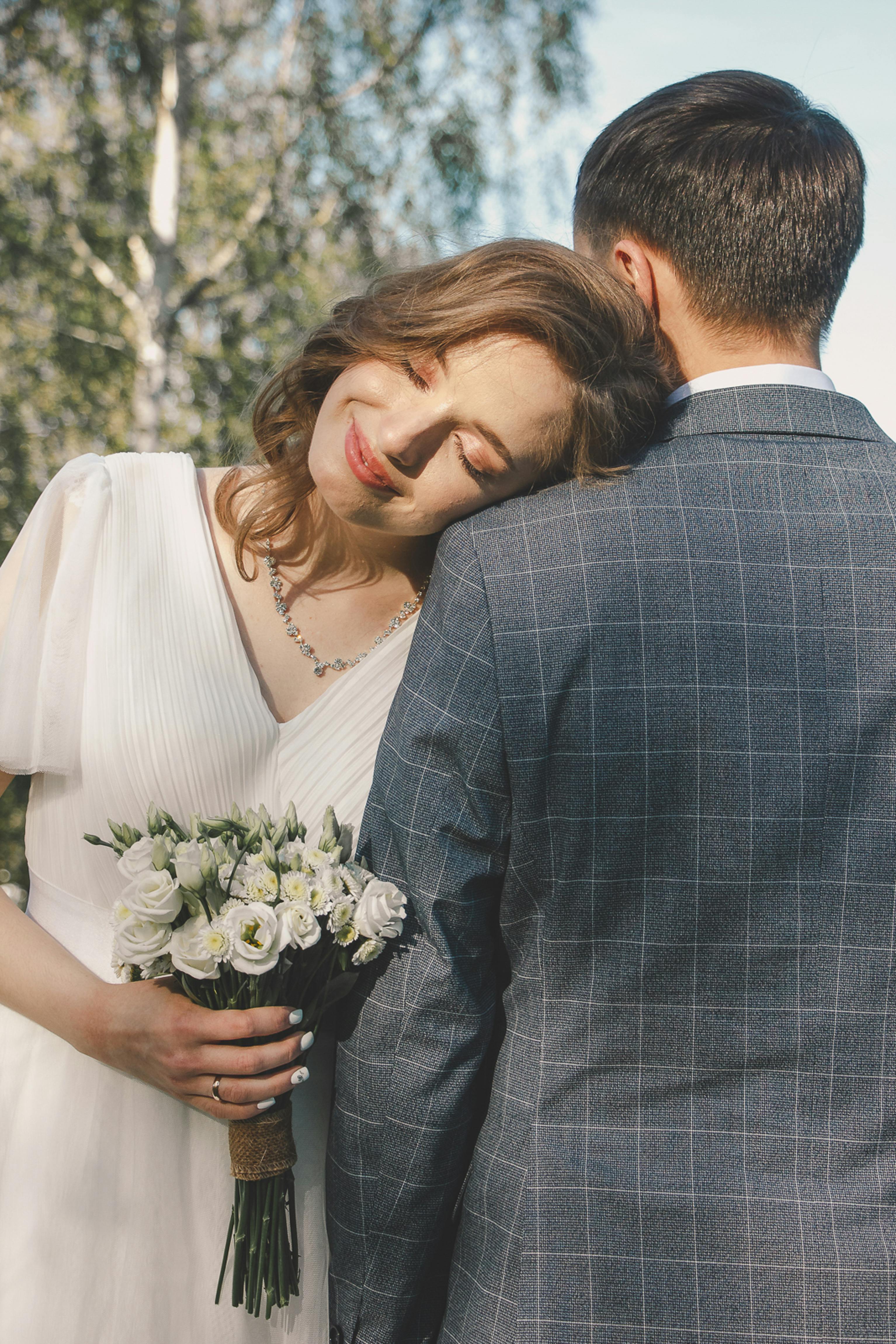 Bride Resting Her Head on the Grooms Shoulder · Free Stock Photo