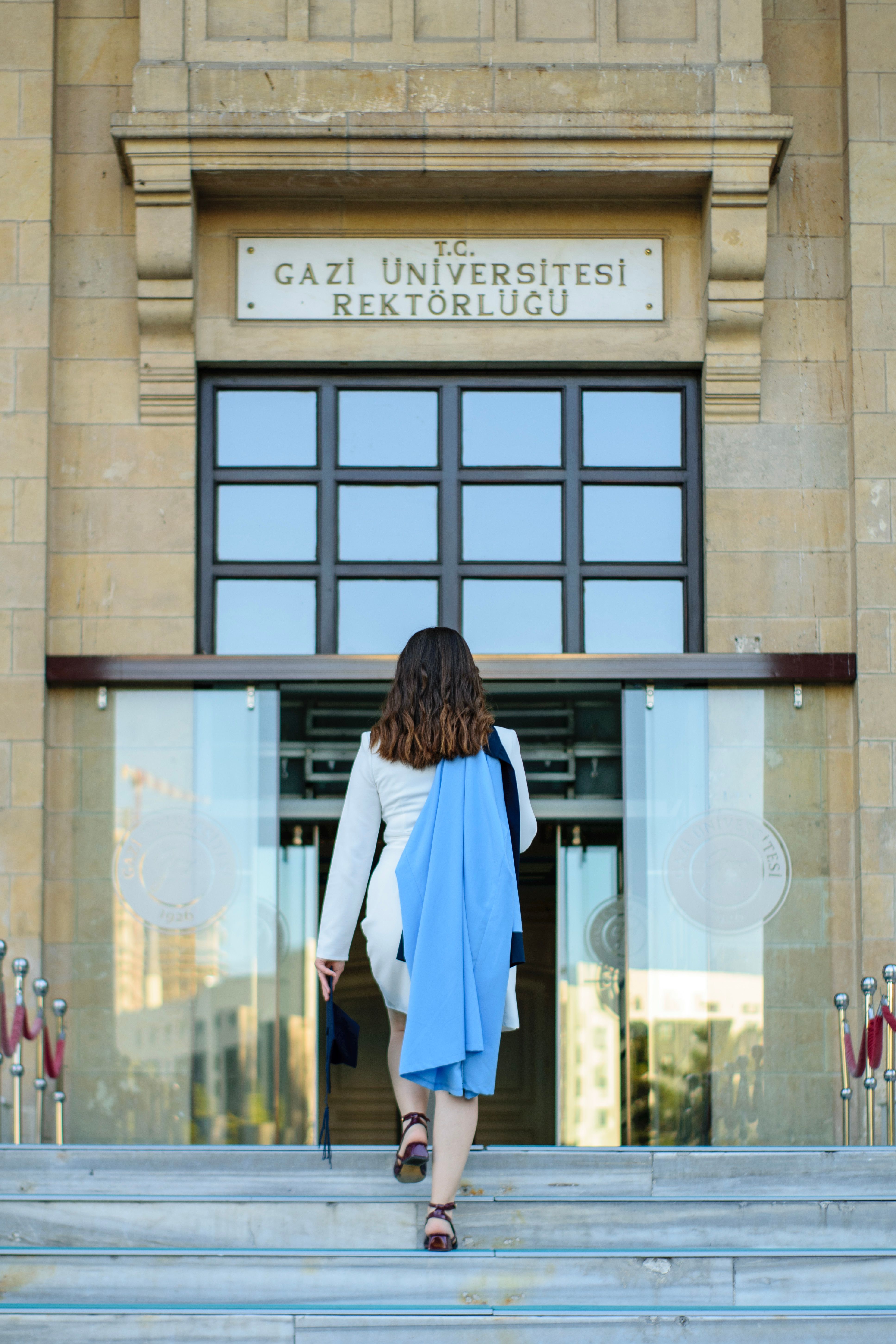 A woman walking up the steps of a building · Free Stock Photo