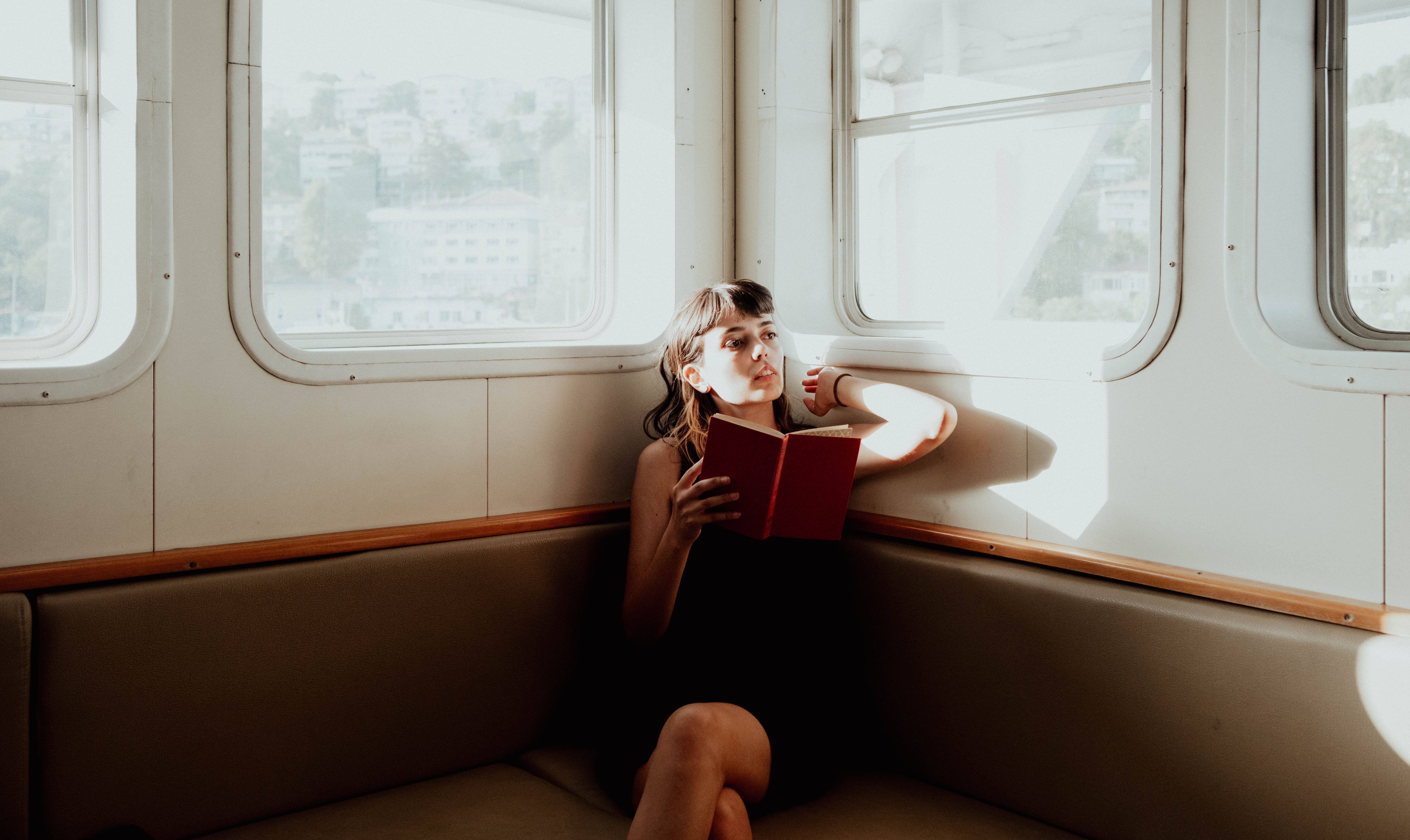 A woman reading a book on a boat · Free Stock Photo