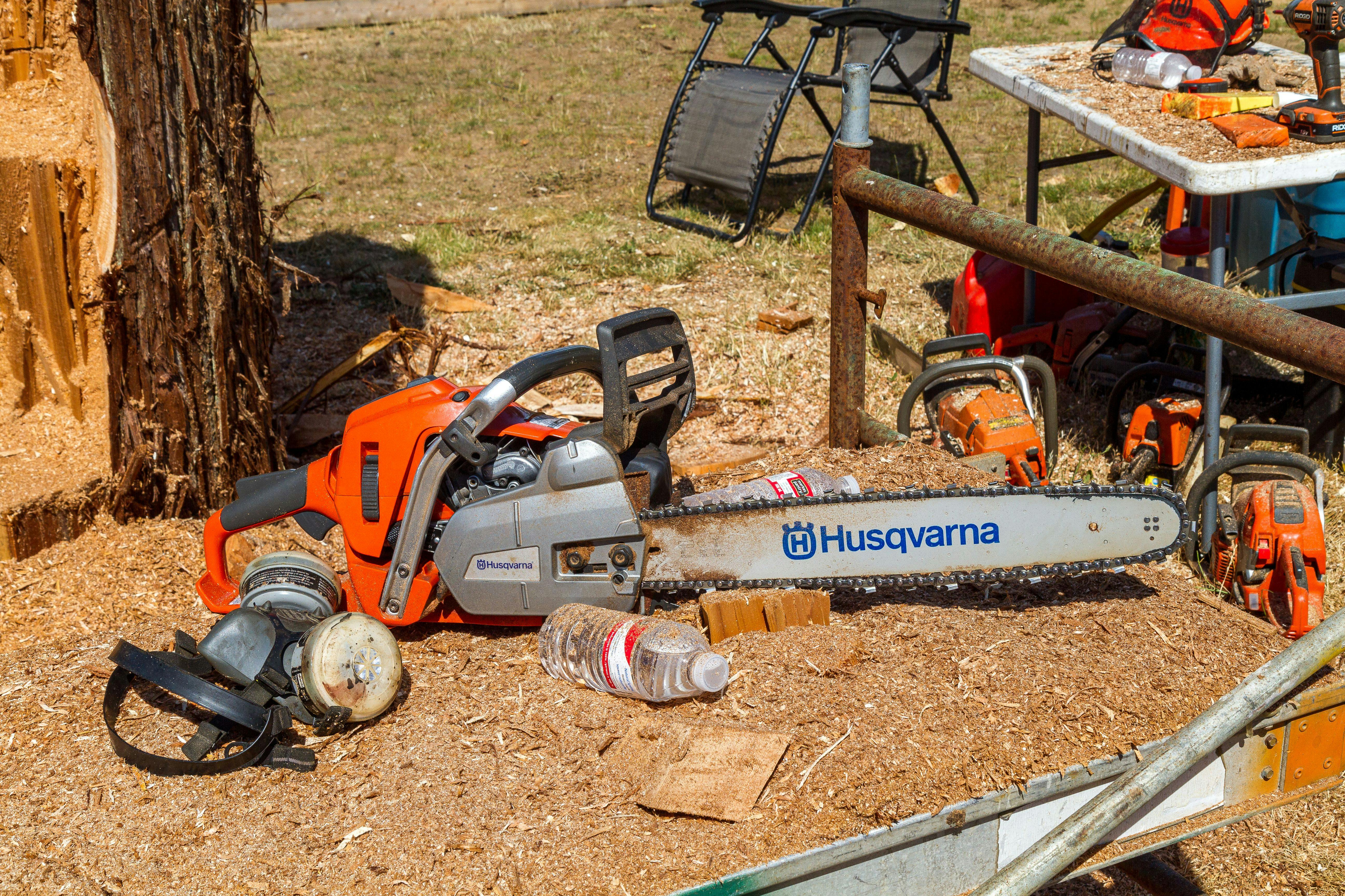 Chain saw in the dirt · Free Stock Photo