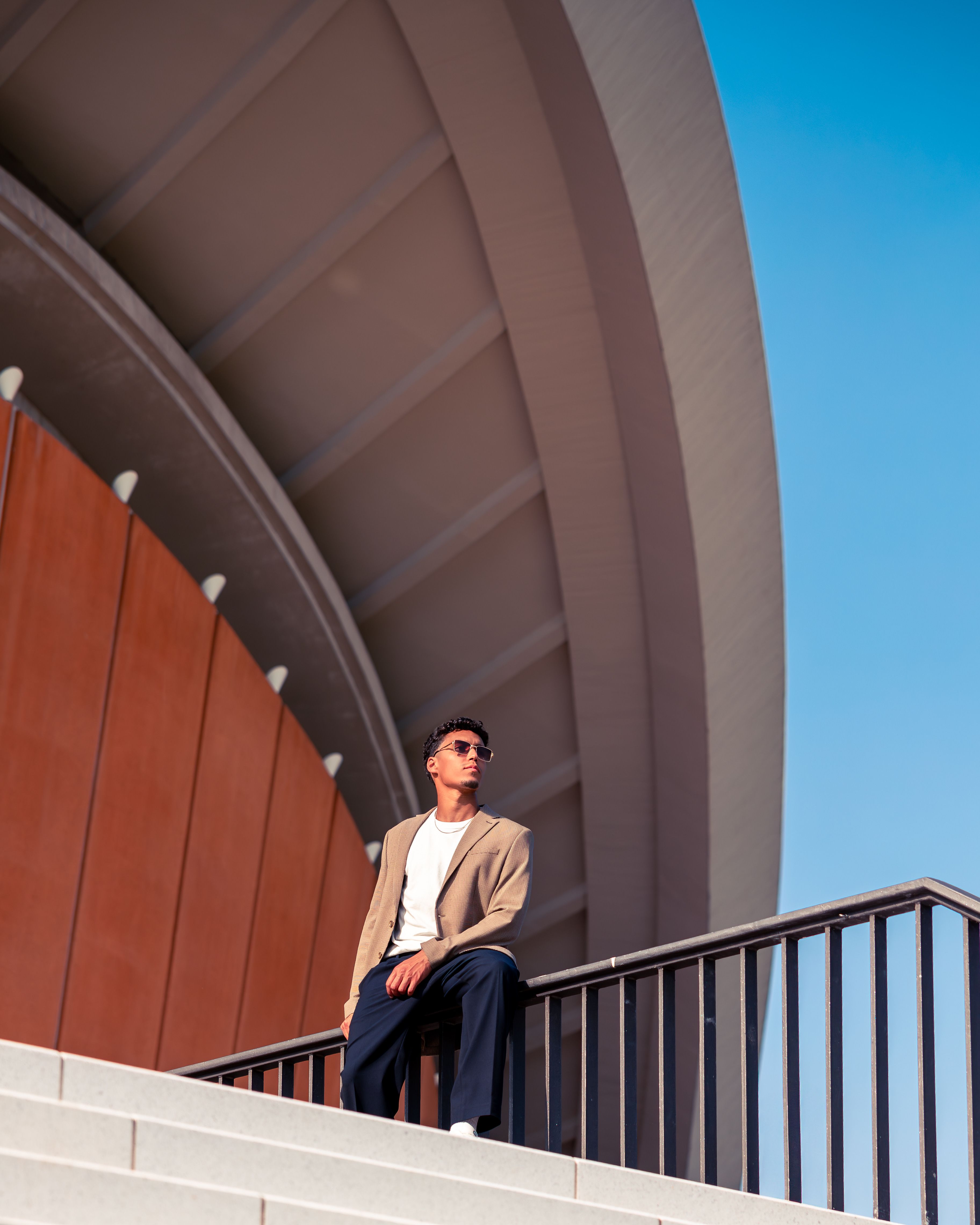 A man sitting on the steps of a building · Free Stock Photo