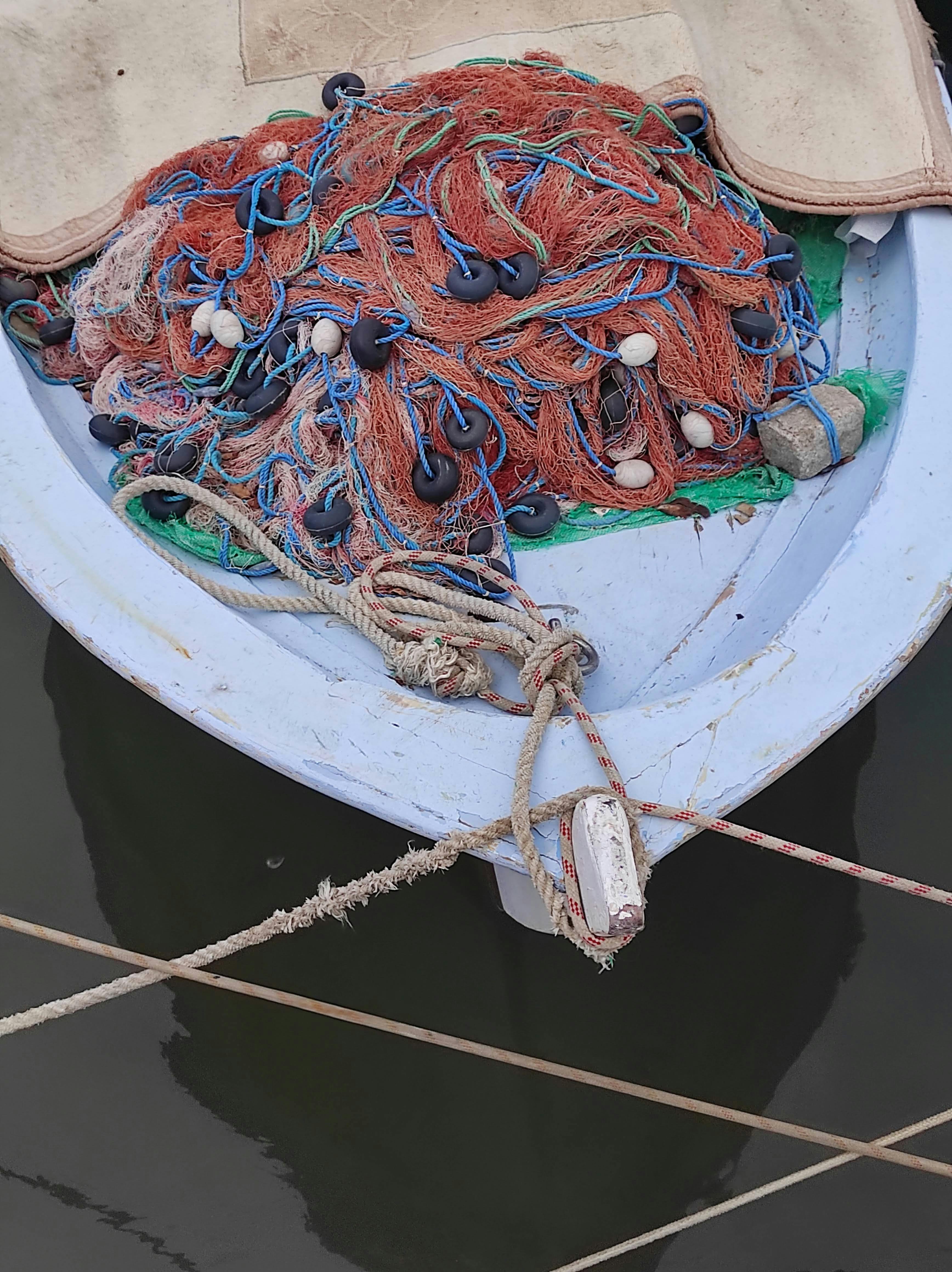 Close-up of a Fishing Net Lying on the Boat · Free Stock Photo