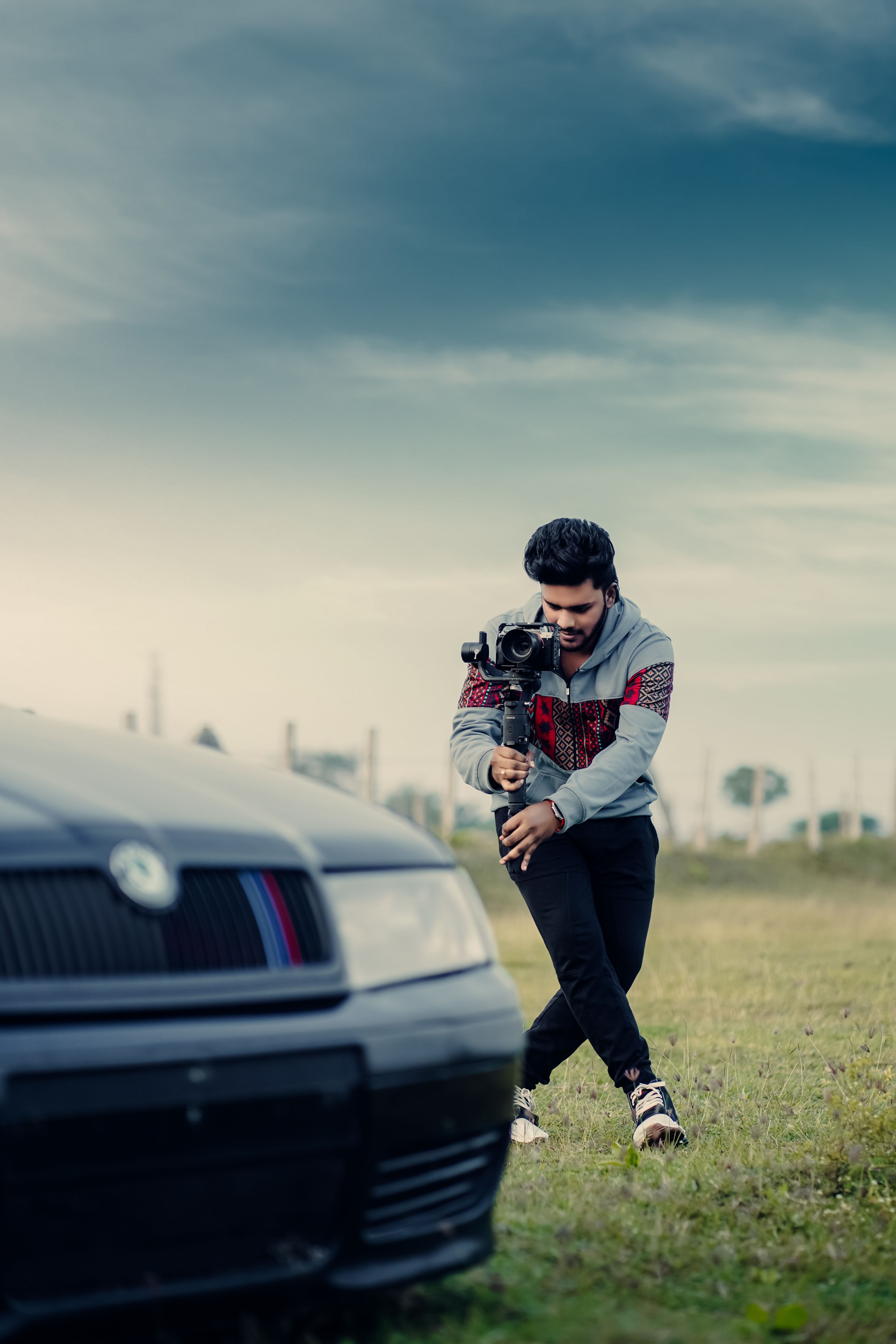 A Man Filming a Car with a Camera · Free Stock Photo