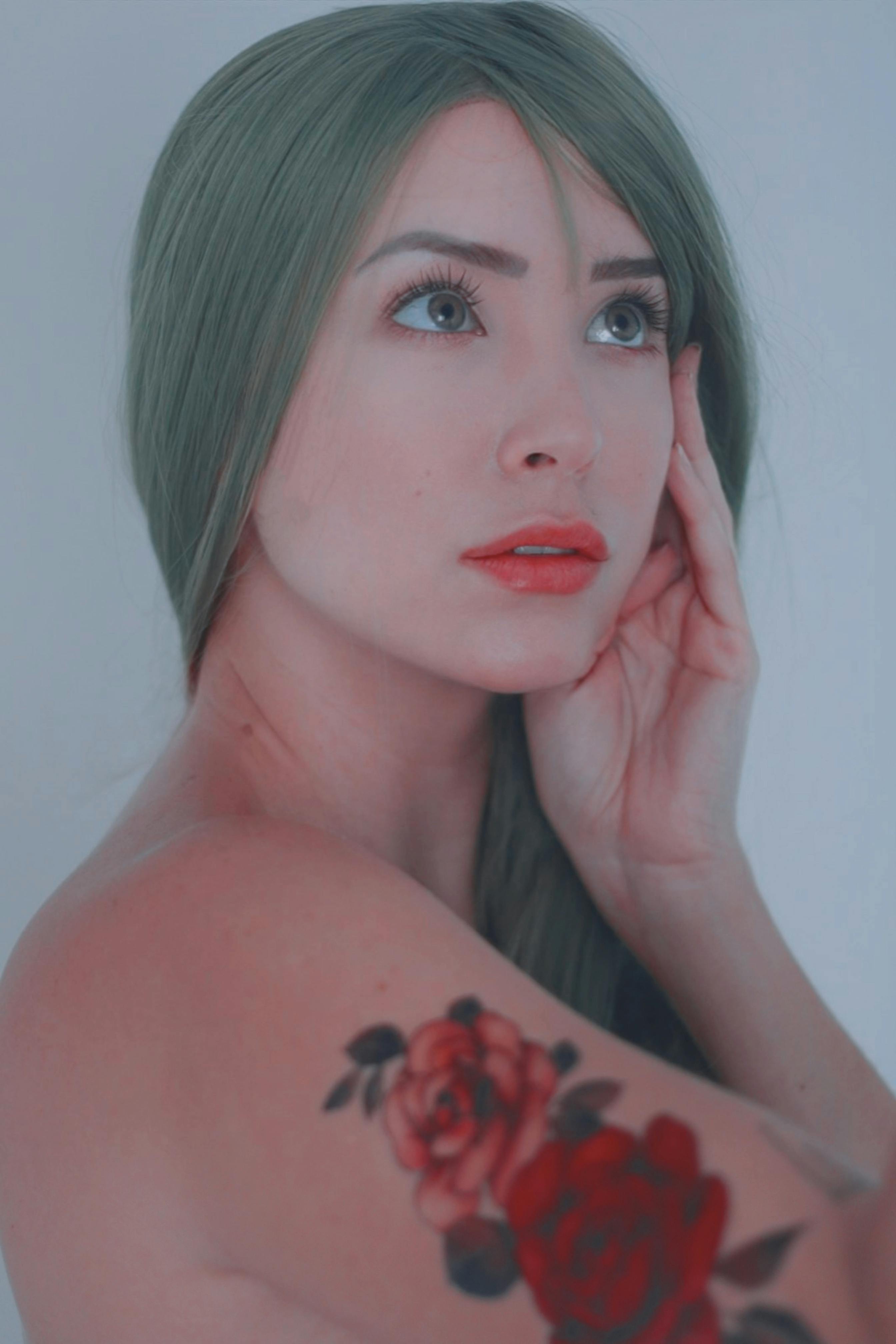 Woman with Turquoise Hair and Red Roses Tattoo on Arm · Free Stock Photo